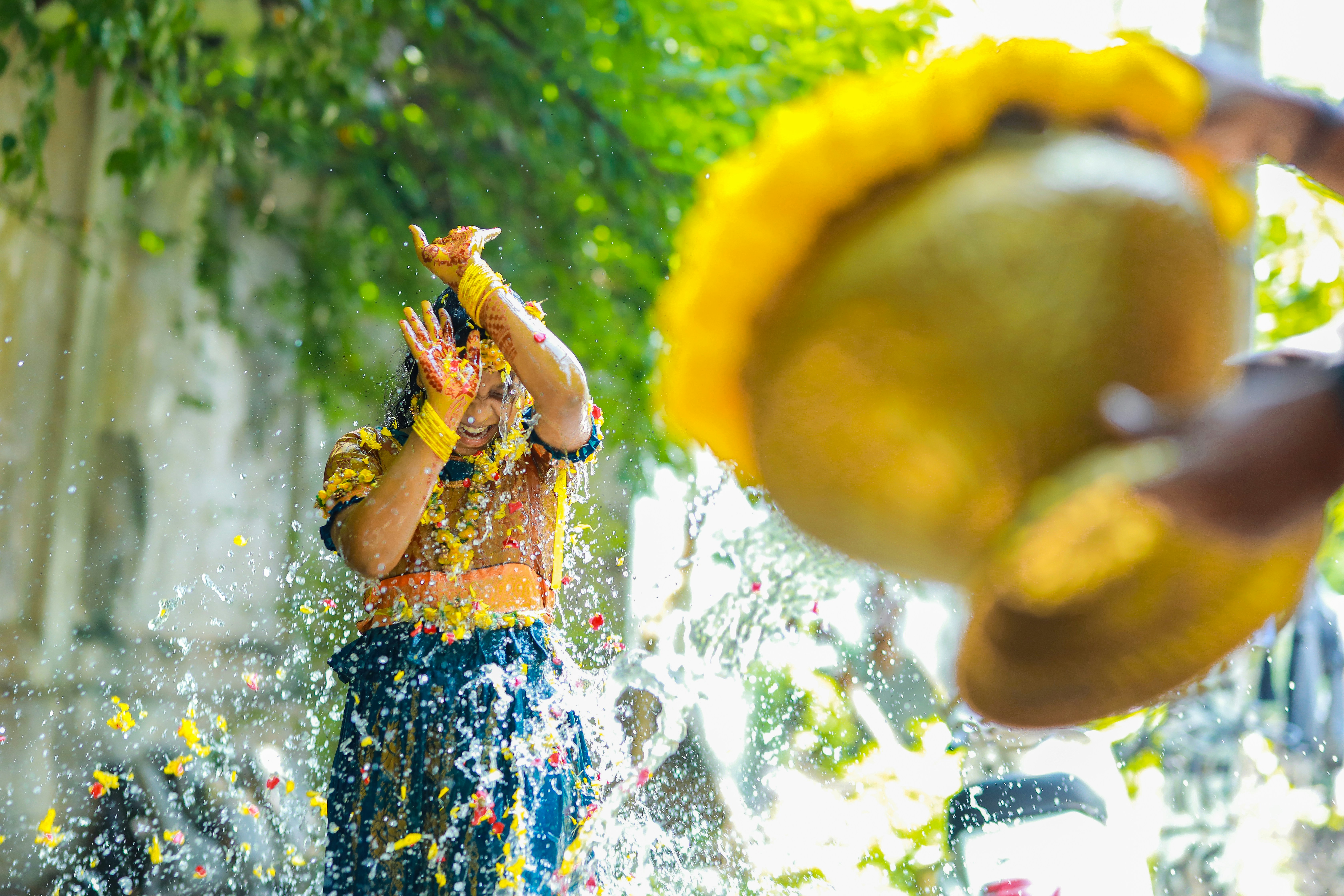 A man is throwing water on himself in the street photo – Free Human ...