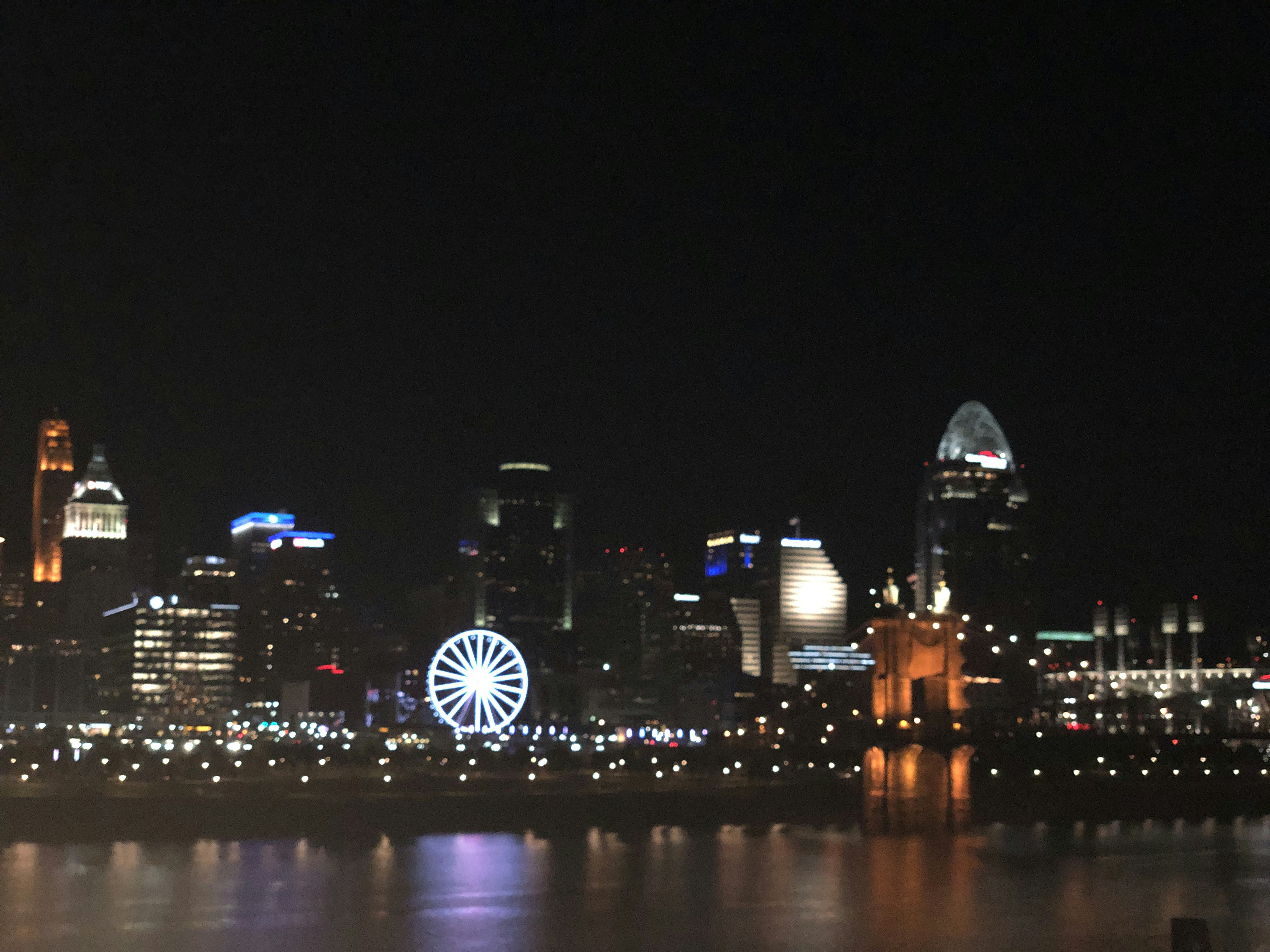 Circling Lights Over the River: Night Skyline with a Ferris Wheel