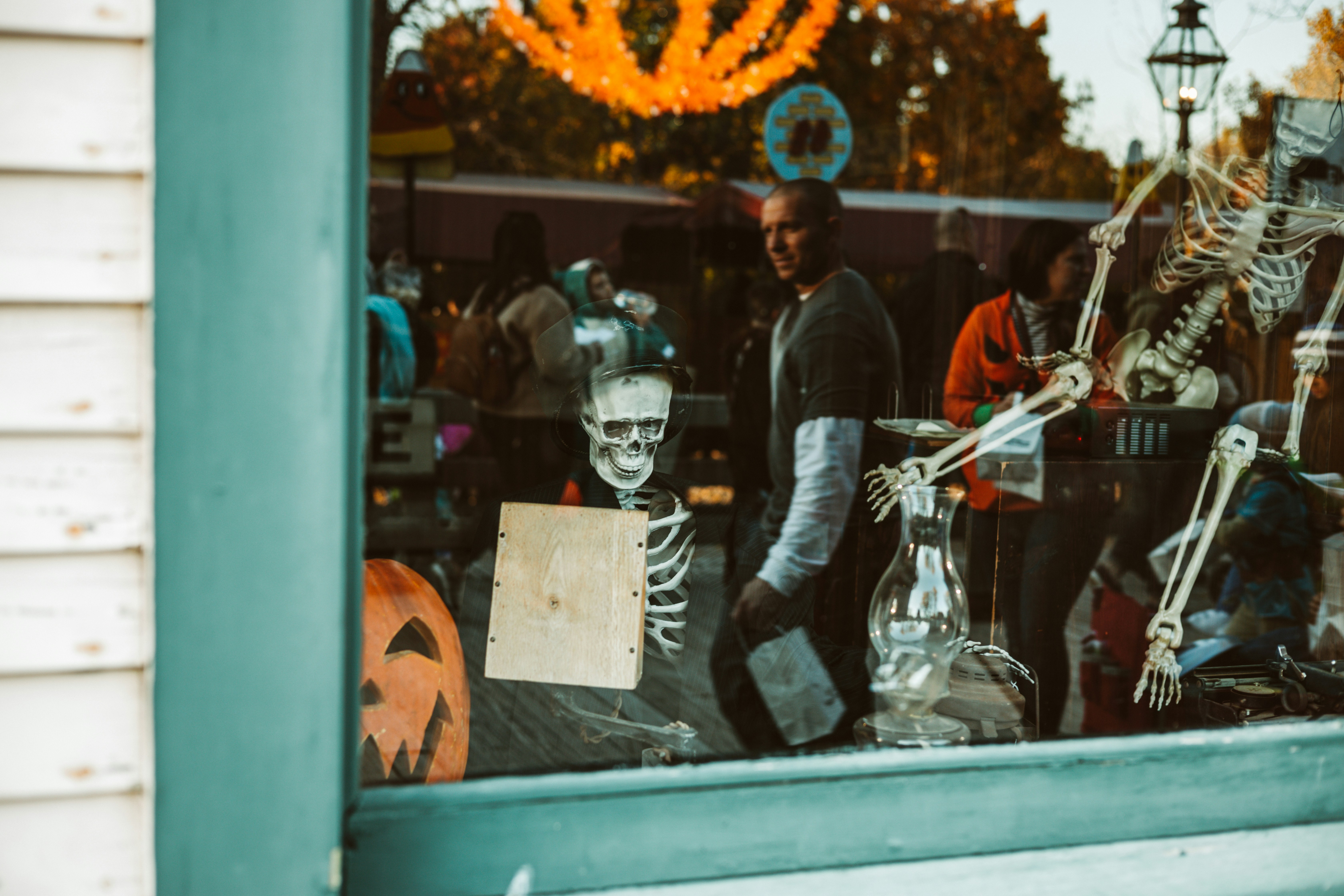 Skeleton in the Shop Window: Halloween Décor Amid Silent Passersby