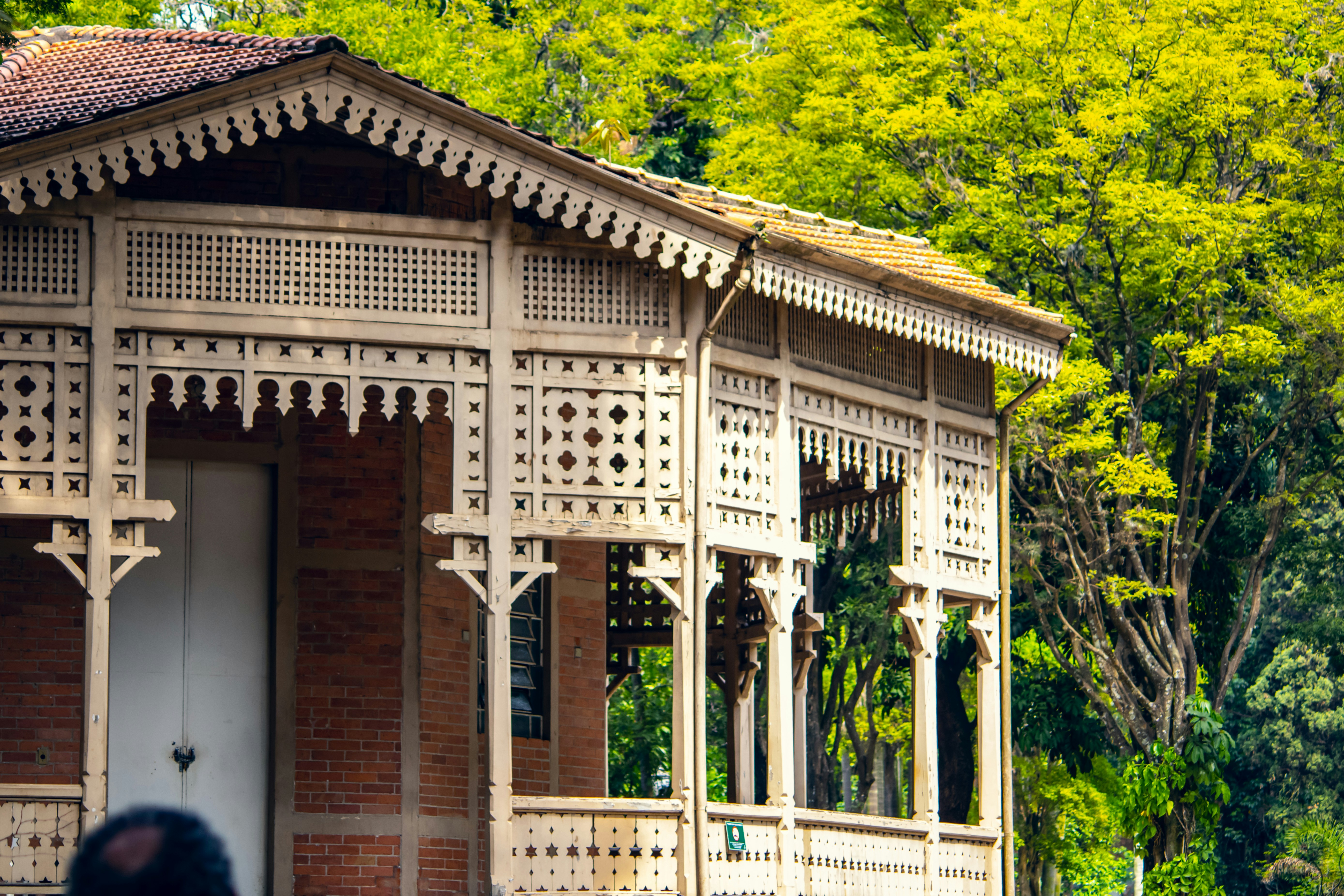 Sunlit Carved Pavilion: Delicate Lacework in a Quiet Garden