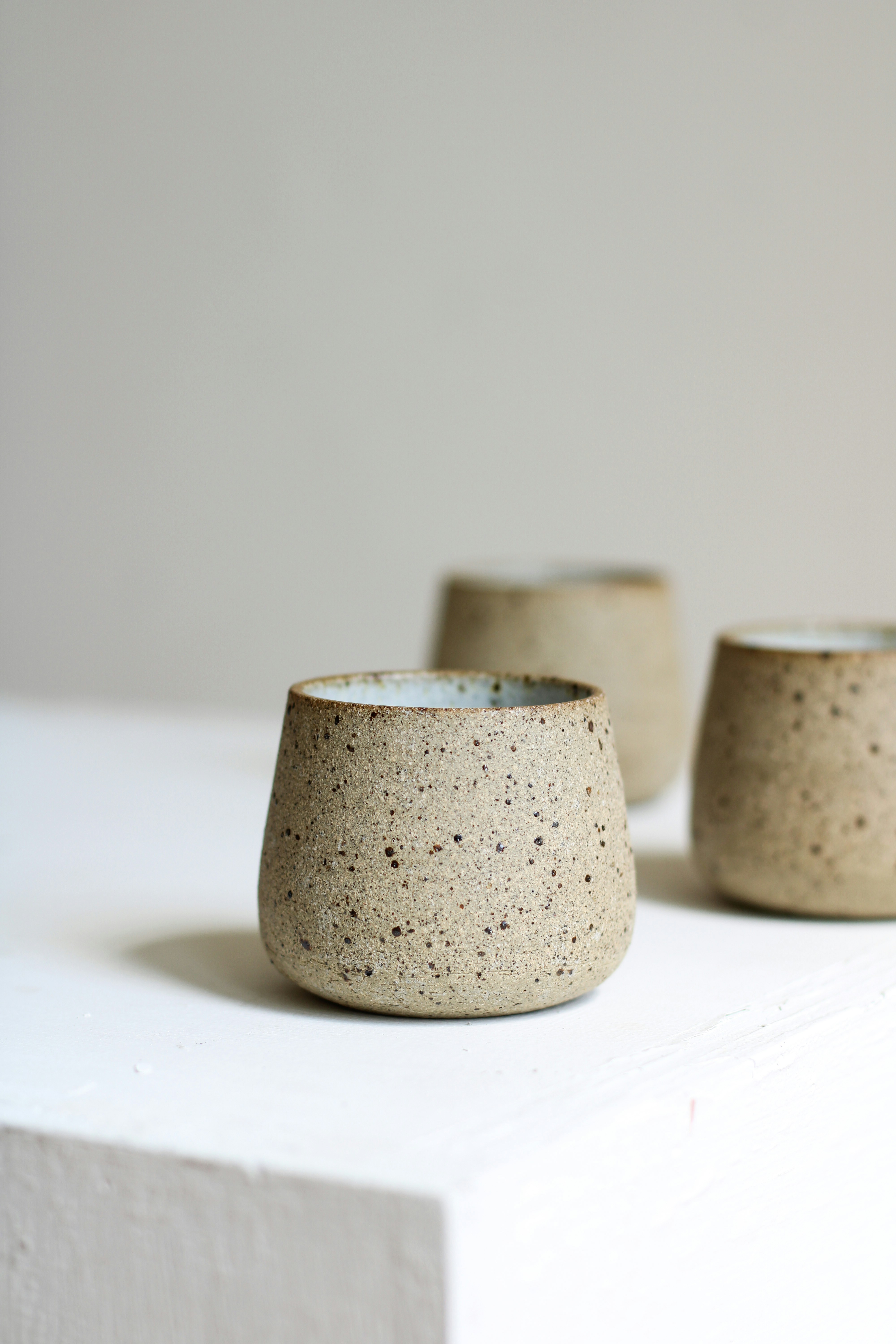 A group of stones on a white surface photo – Free Espresso cups Image ...