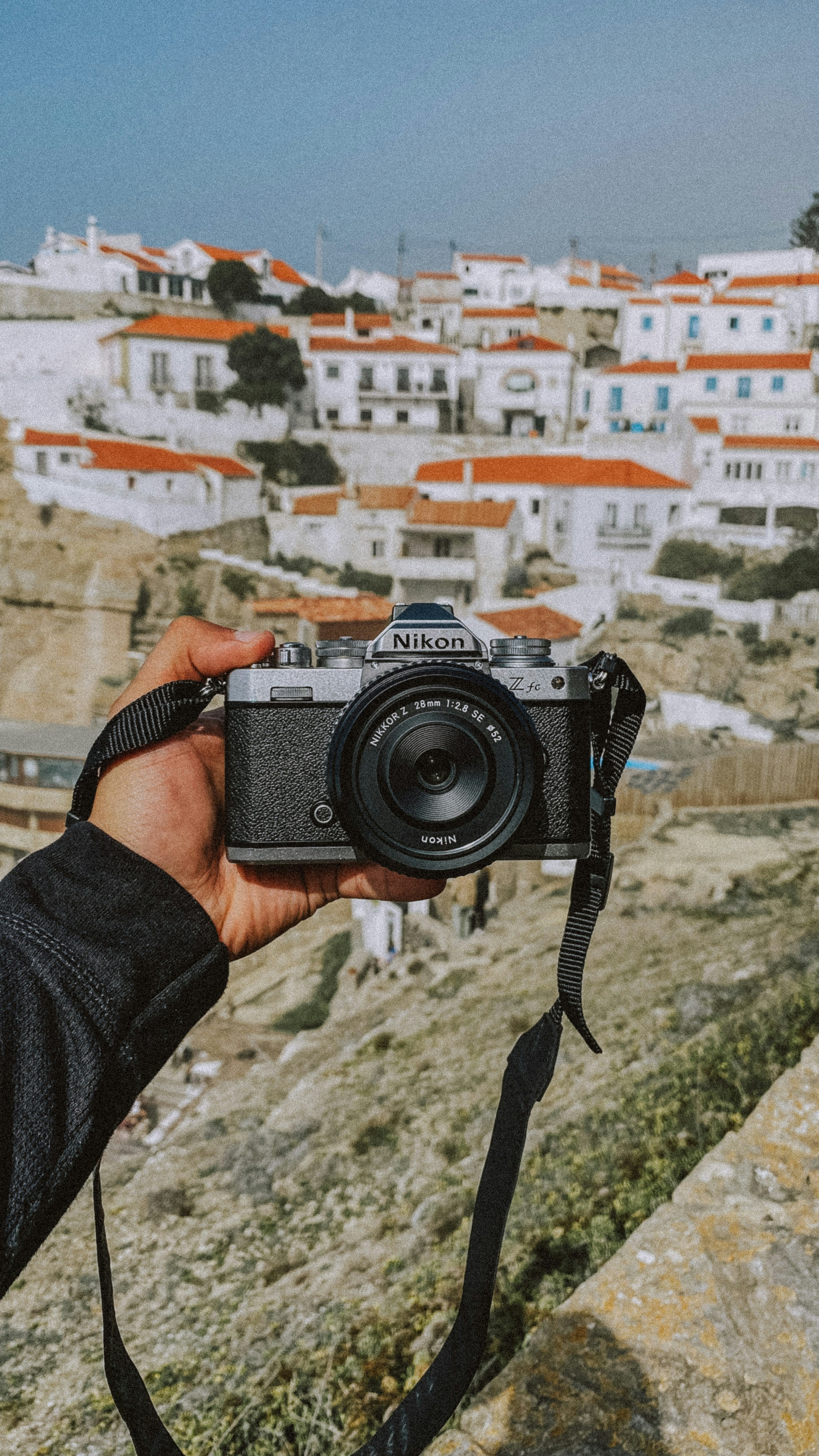 Crimson Roofs, White Walls: A Handheld Nikon Over a Cliffside Village
