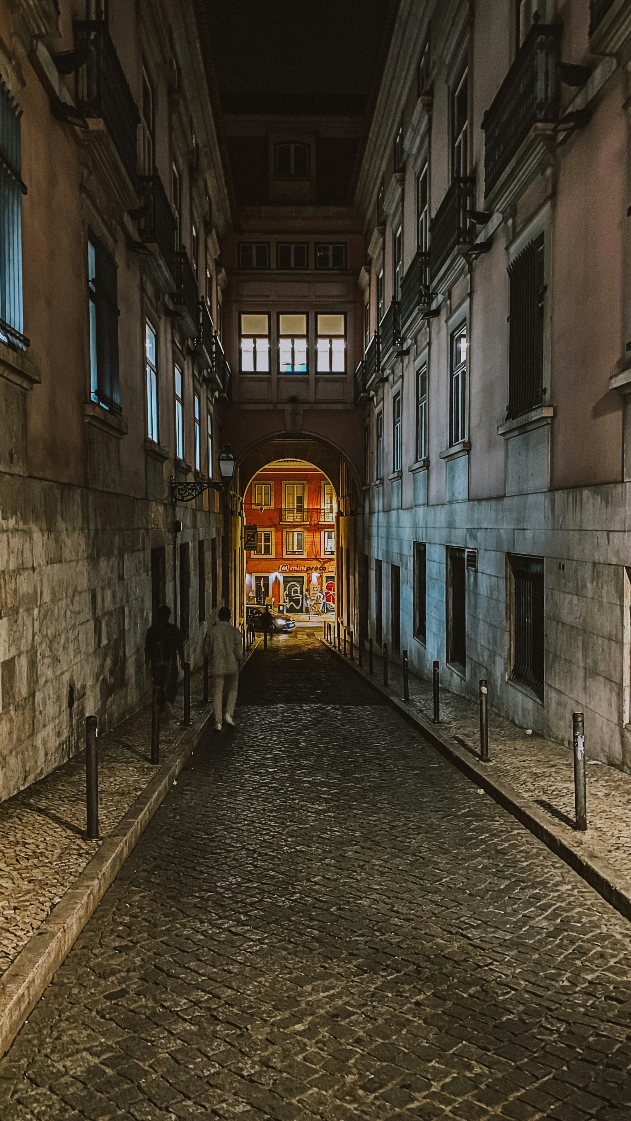 a cobblestone street between buildings