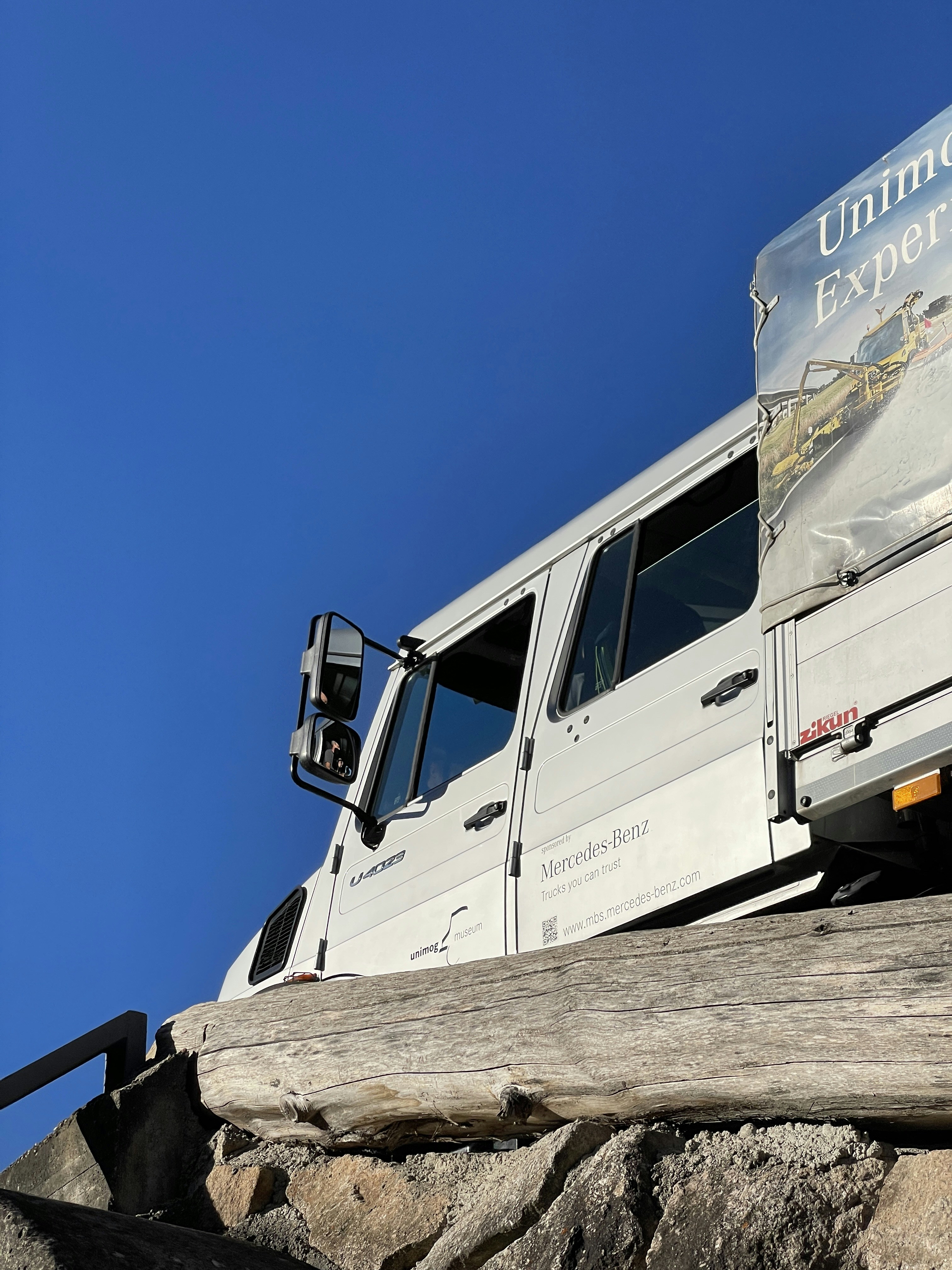 a white truck parked on a rock