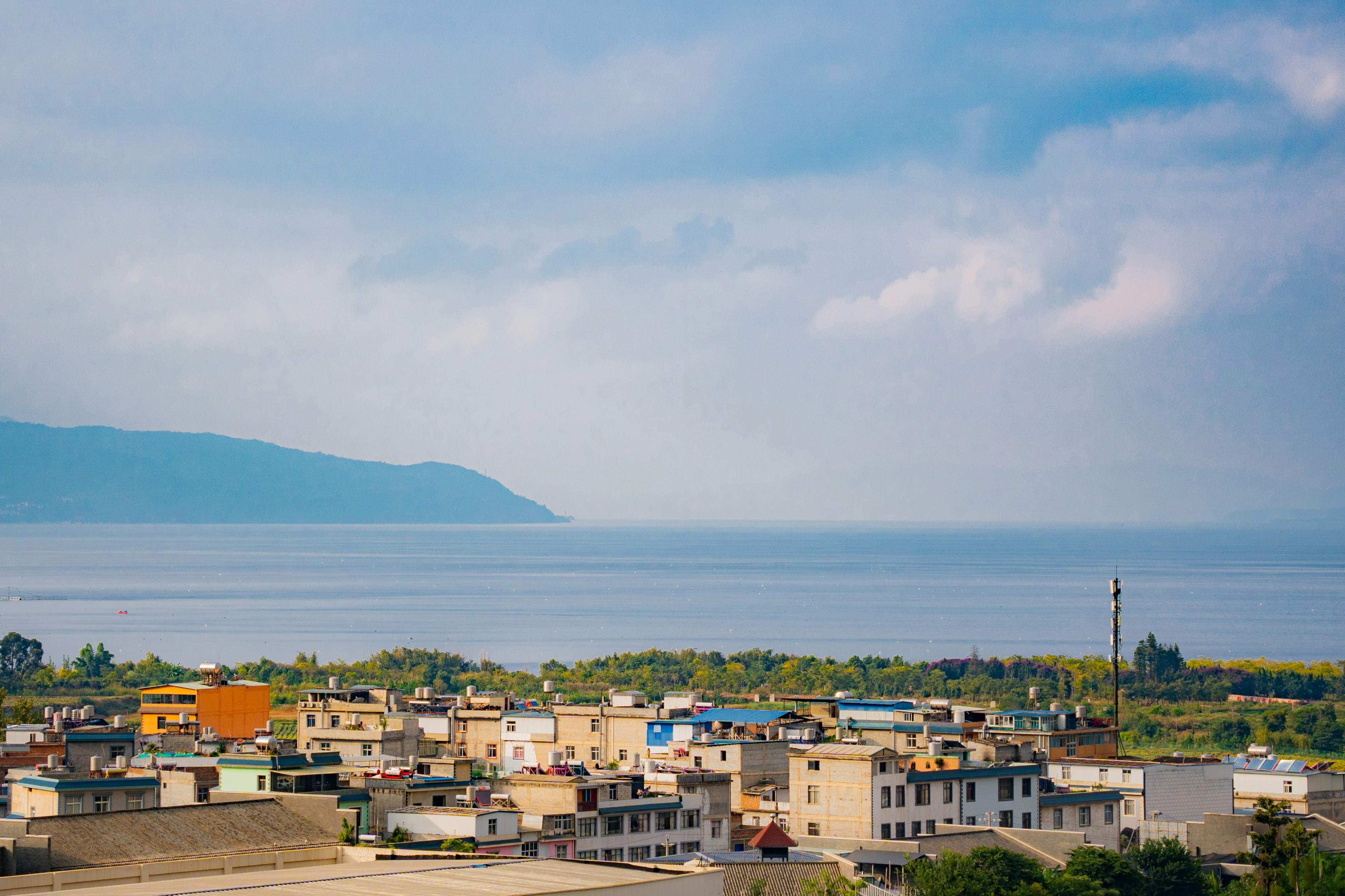 a city with a body of water in the background