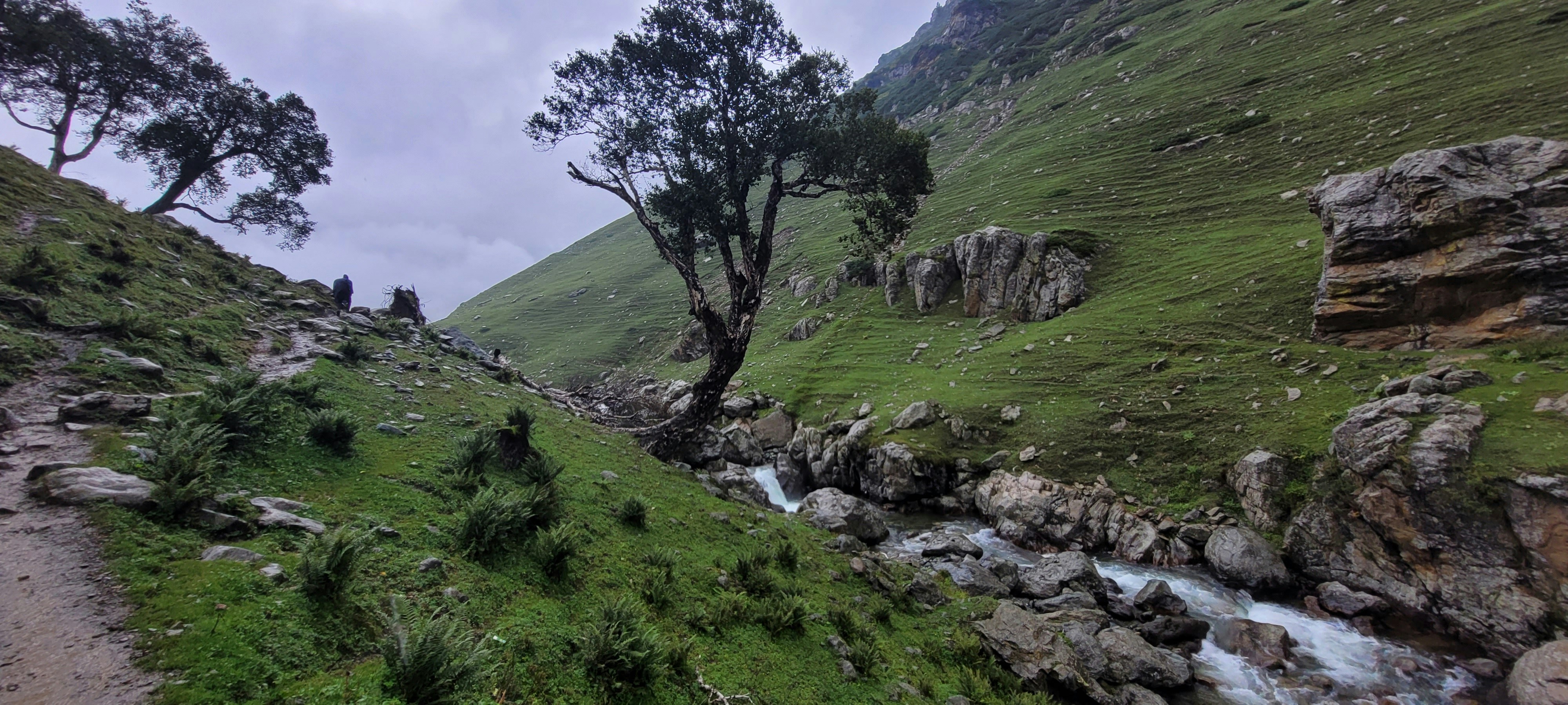 A rocky hillside with a stream running through it photo – Free Mountain ...