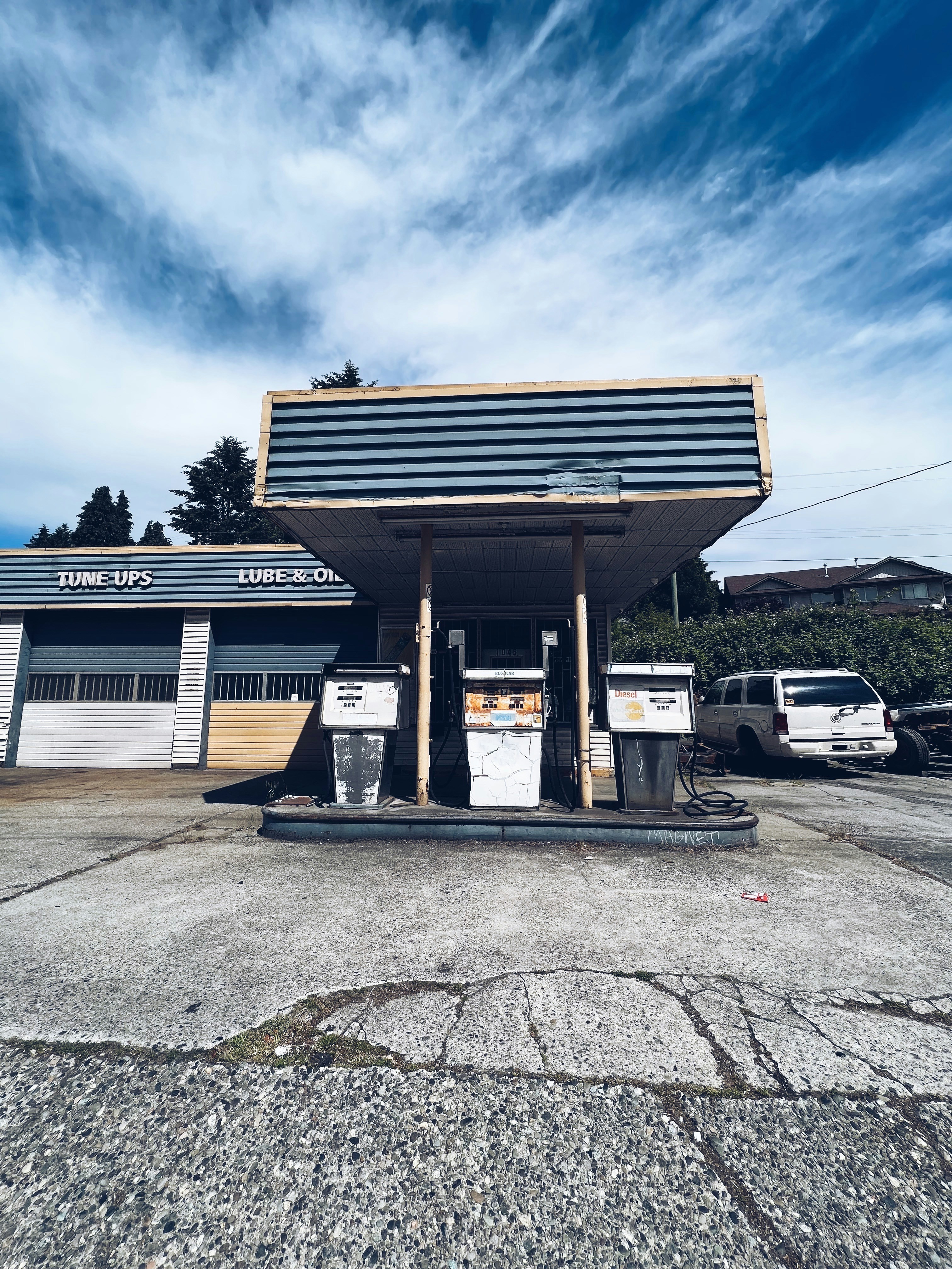 A gas station with a car parked in front of it photo – Free Gas station ...