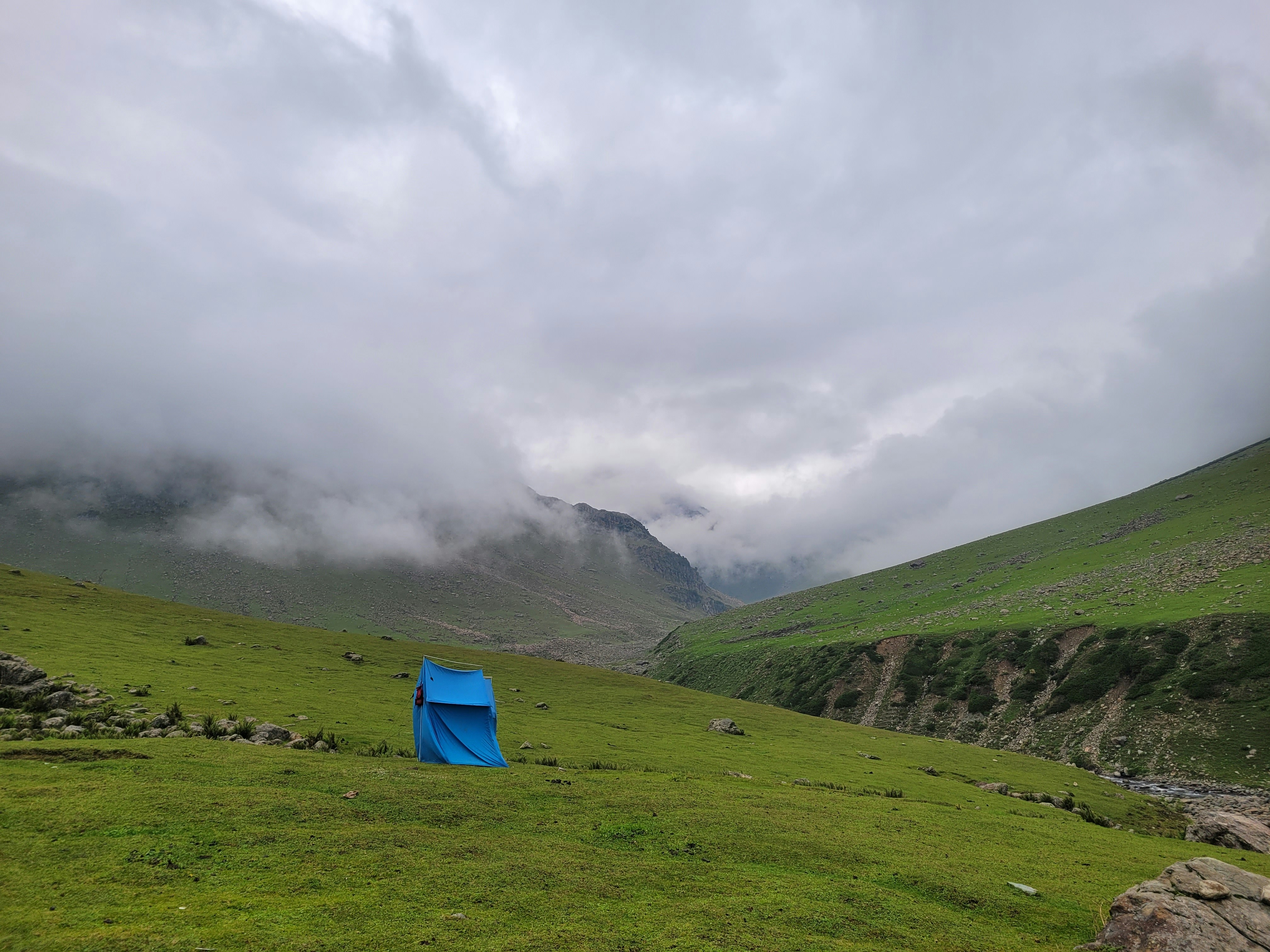 Blue Refuge in a Mist-Lapped Alpine Meadow
