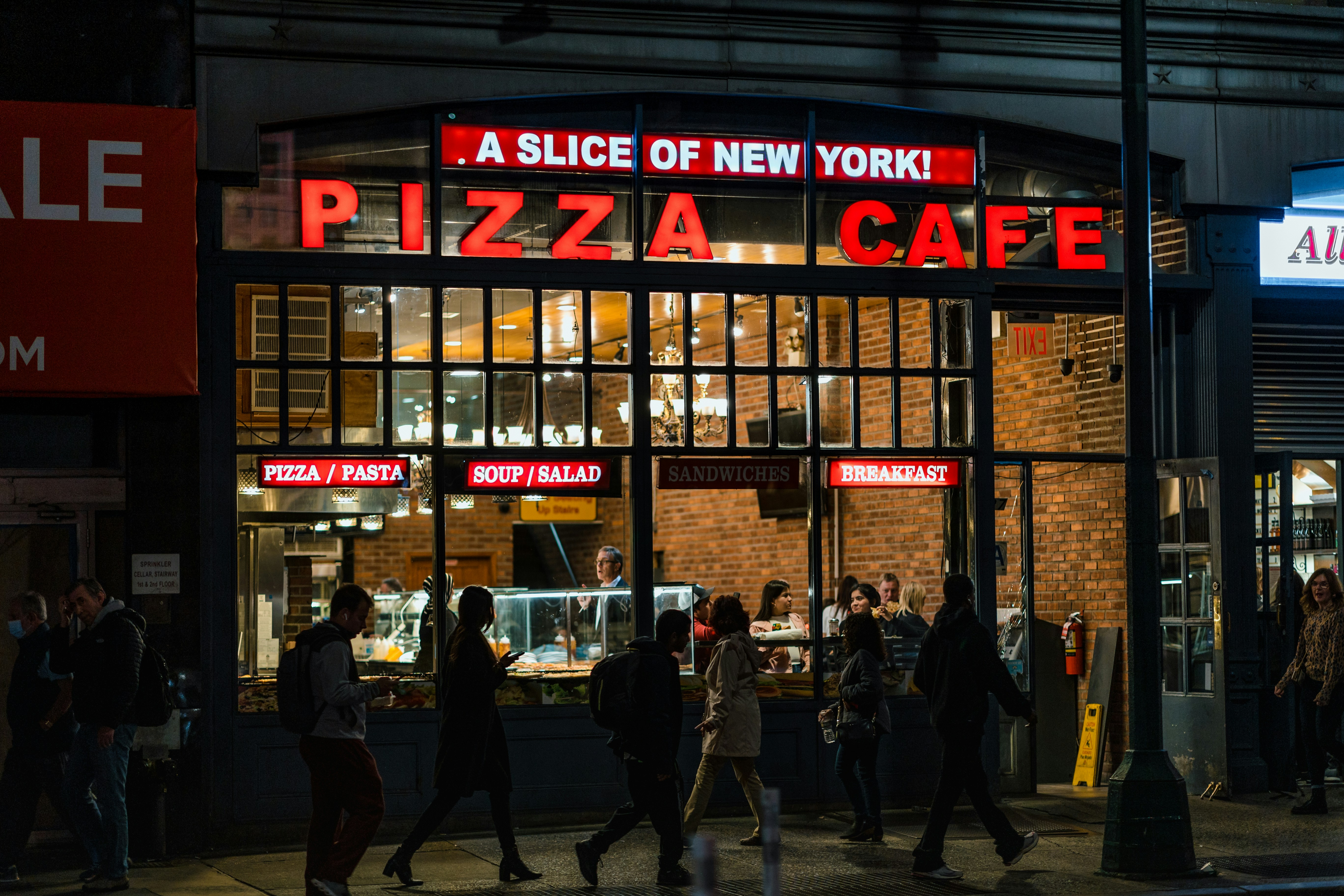 A group of people walking outside of a building photo – Free Human ...