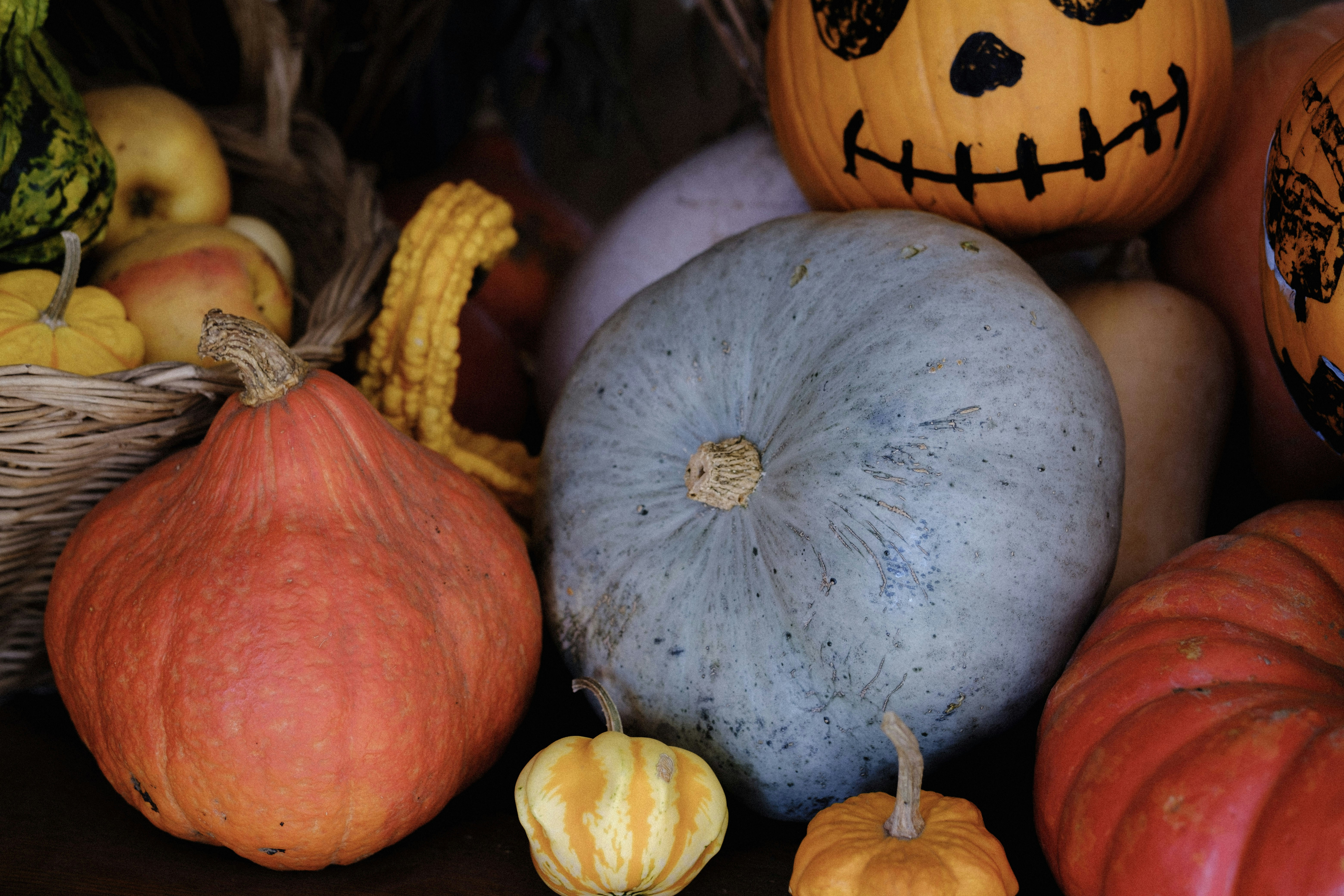 a group of pumpkins with faces drawn on them