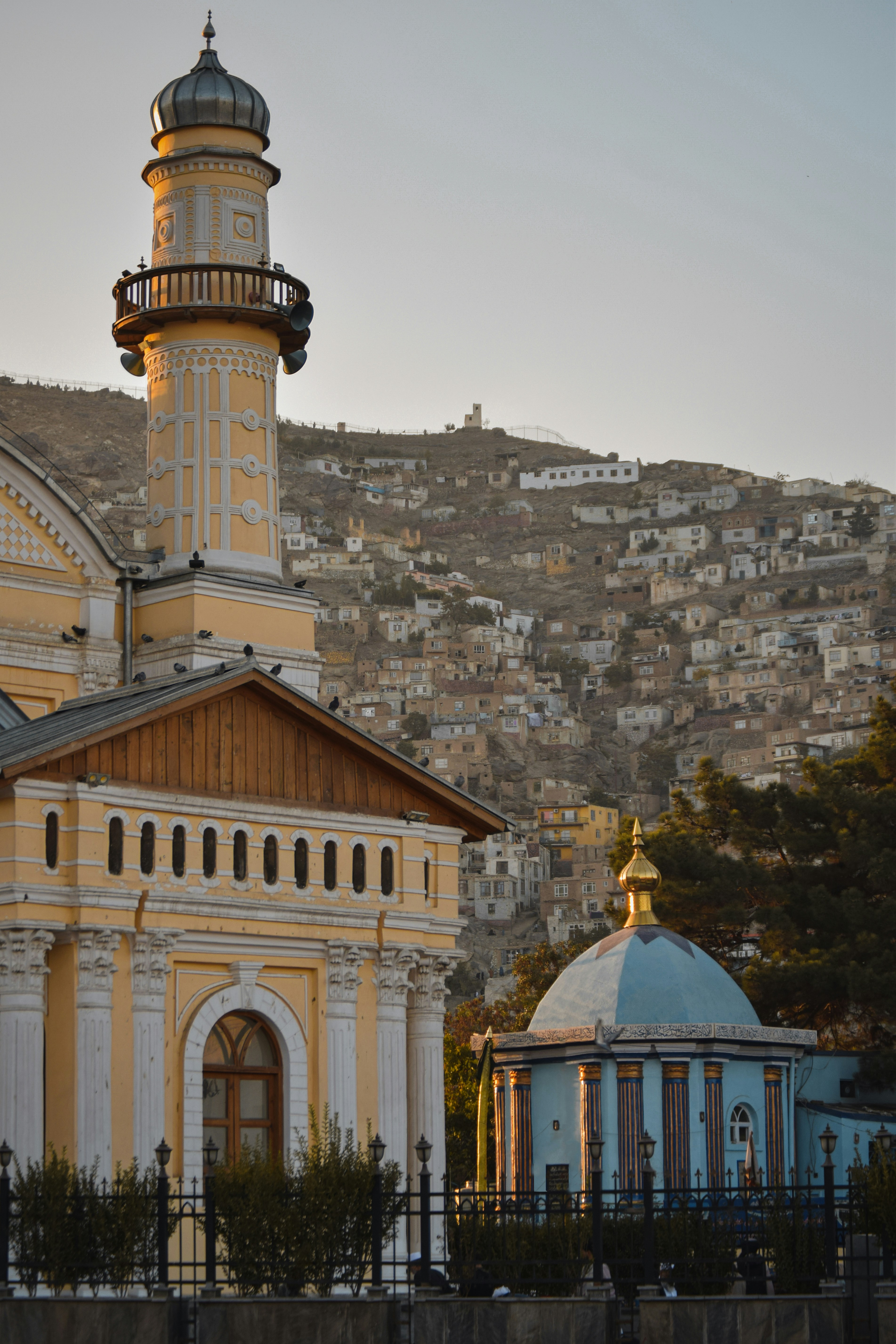 A building with a tower and a hill in the background photo – Free Kabul ...