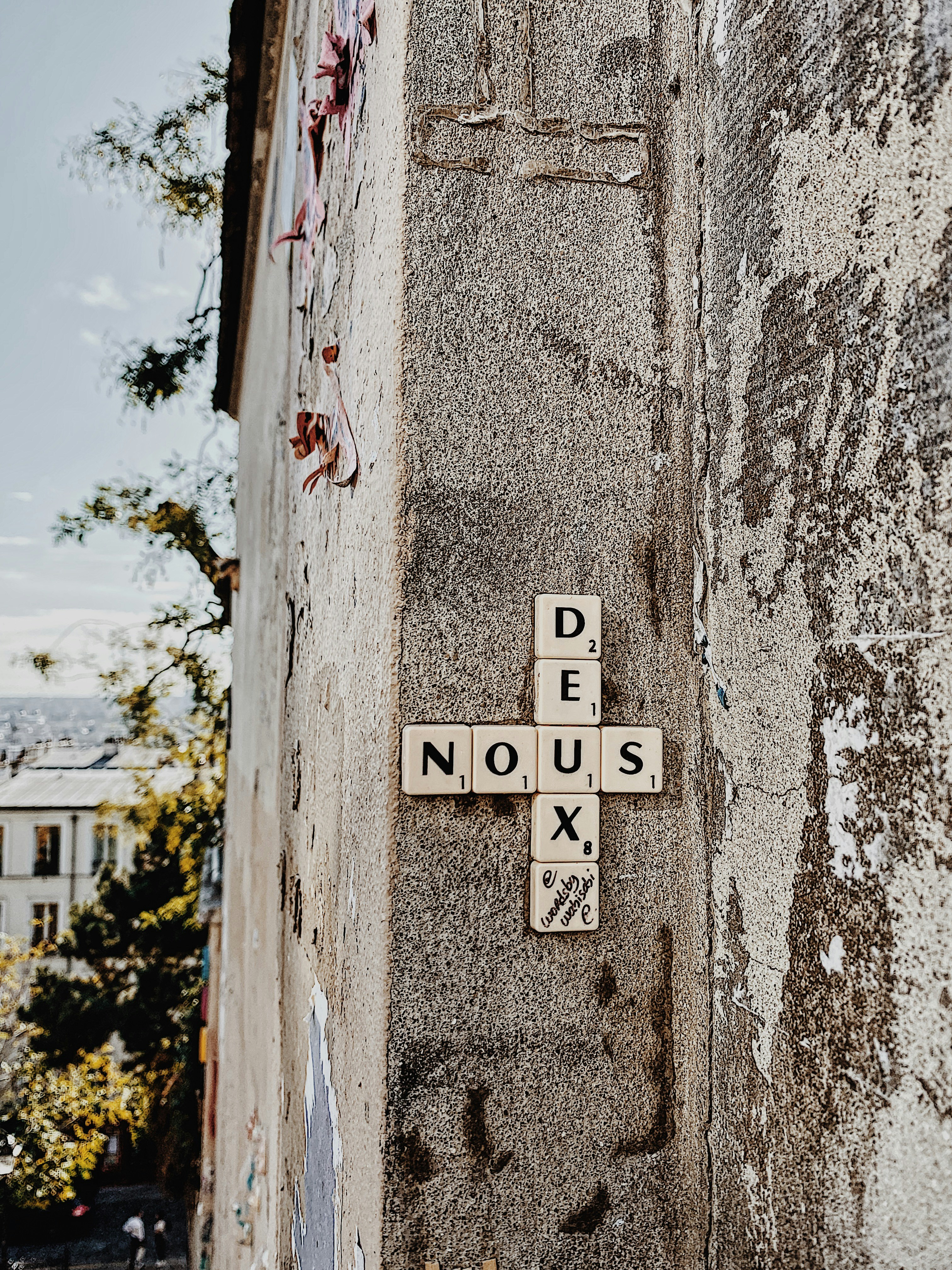 Urban Facade Glyphs: Scrabble Tiles on a Weathered Corner