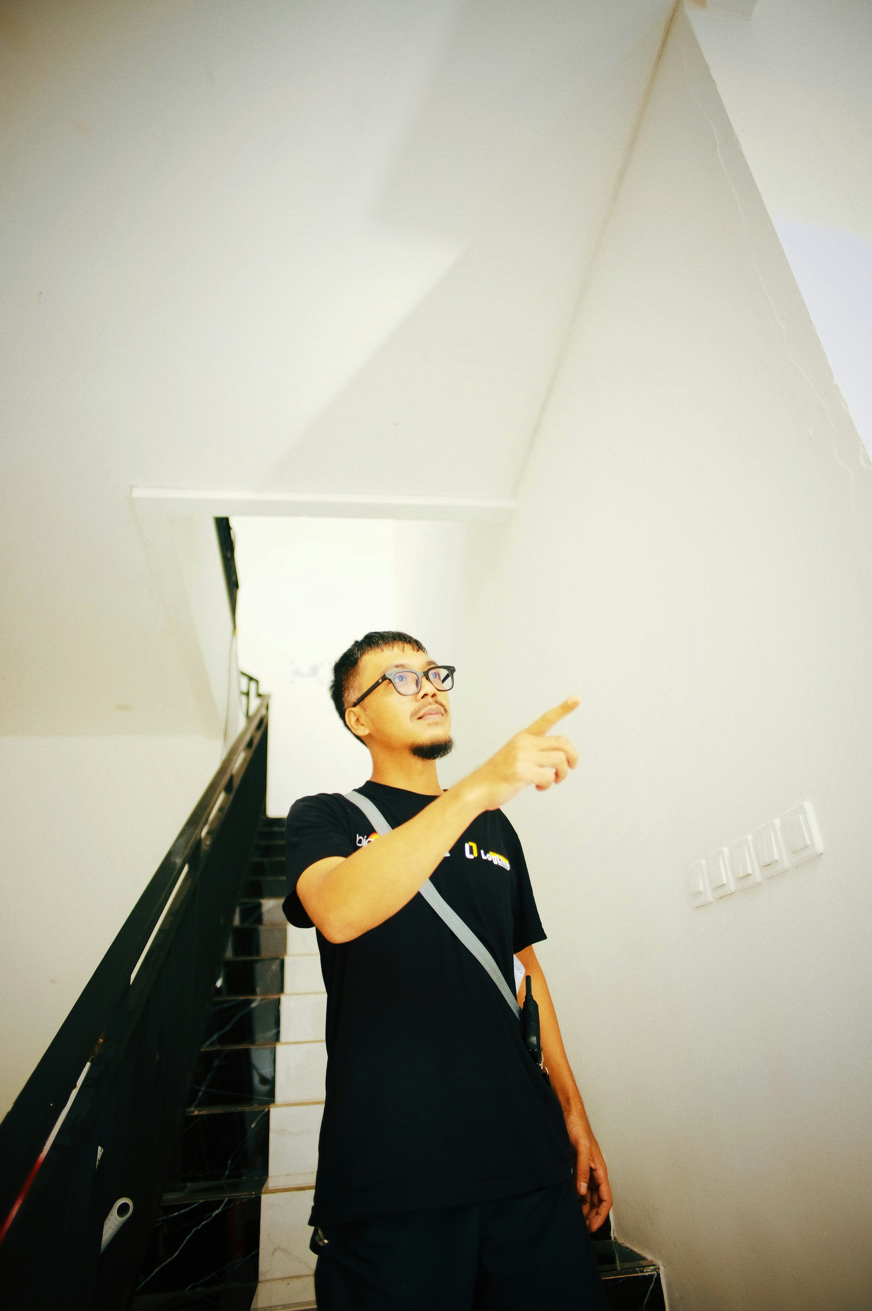 Pointing Toward the Next Floor: Portrait in a Minimal Stairwell