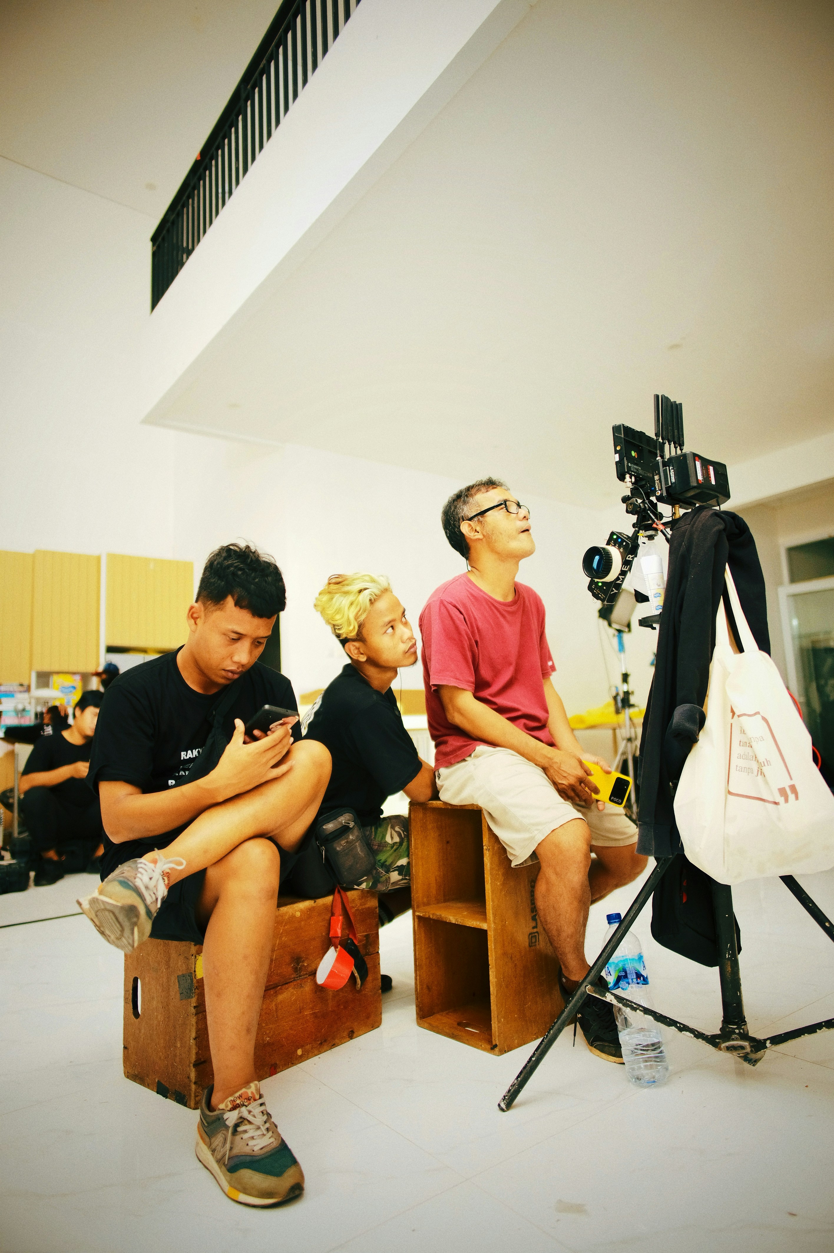 A group of people sitting on a bench with cameras and a camera photo ...