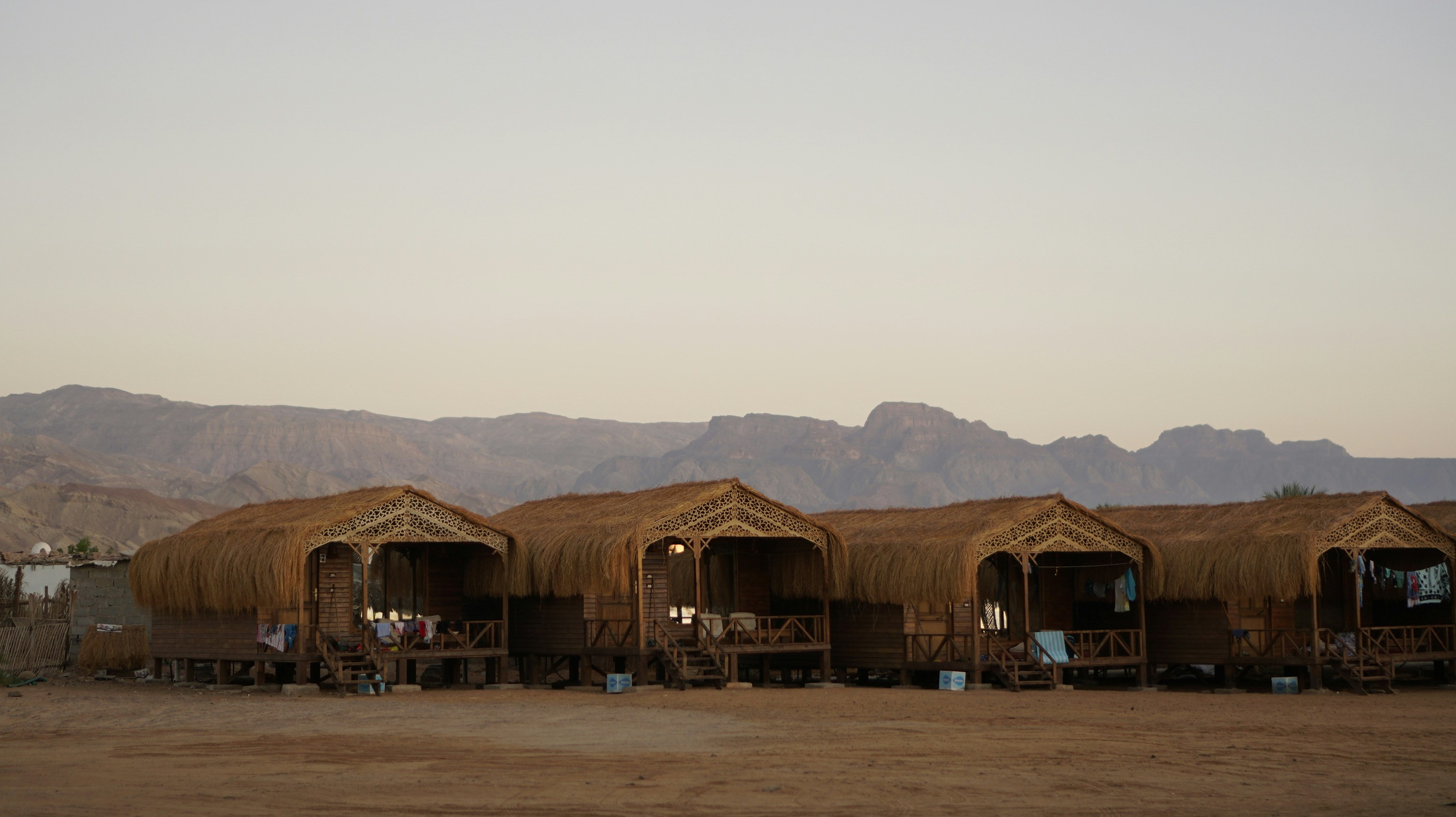 Beach huts, Sinai Beach holiday in the Sinai Peninsula, Egypt. Bir Sweir, Nuweiba area. This is the area of God's Mountain where Moses received the 10 commandments. The beaches here are part of the Red Sea with Saudi Arabia and its proposed mega city Neom just across the water. Sinai is a sustainable travel option. People stay in huts, eat local food and enjoy diving and snorkelling the reefs of the Red Sea, and hiking in the mountains to places like St Catherine's monastery. We'd appreciate a link and credit to Karin Kloosterman, www.greenprophet.com if you use any of these photos.