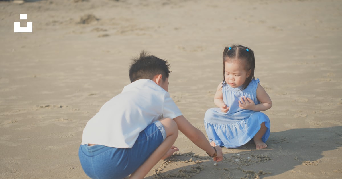 모래에서 노는 남자와 아이 사진 Unsplash의 무료 해안선 이미지