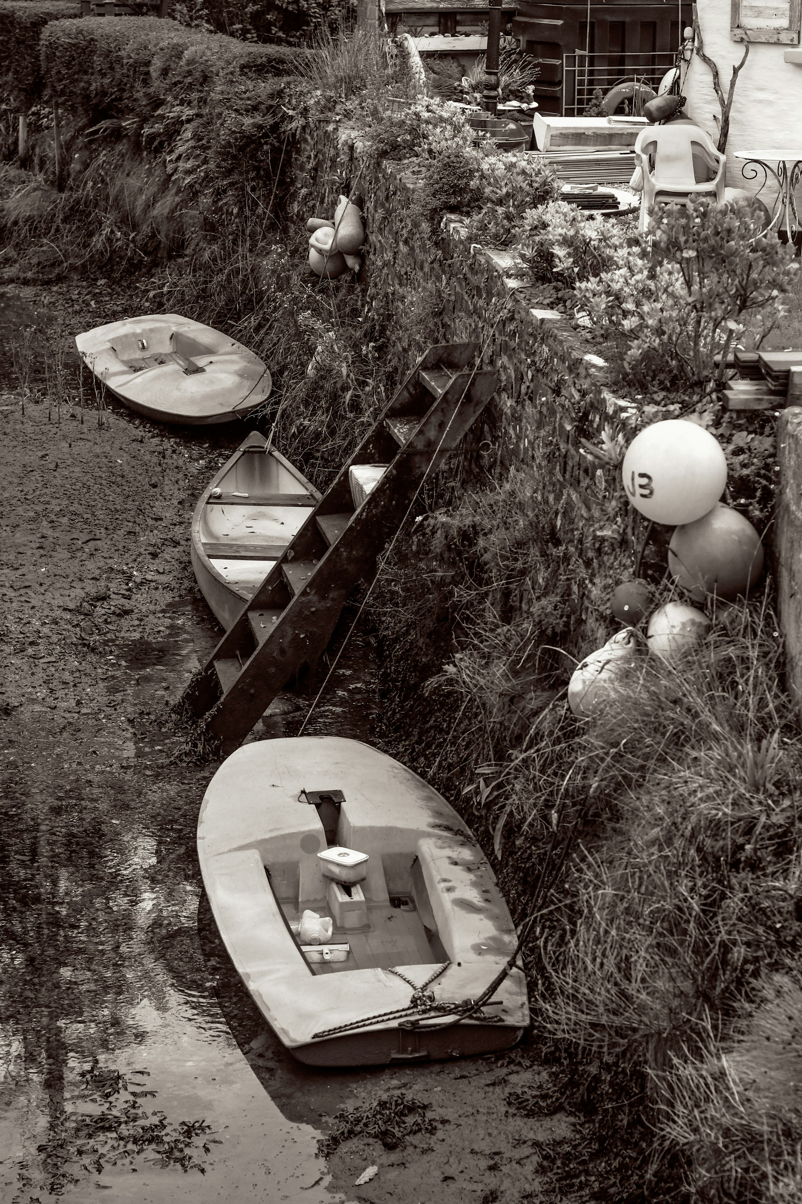 a couple of boats sit on the shore of a lake