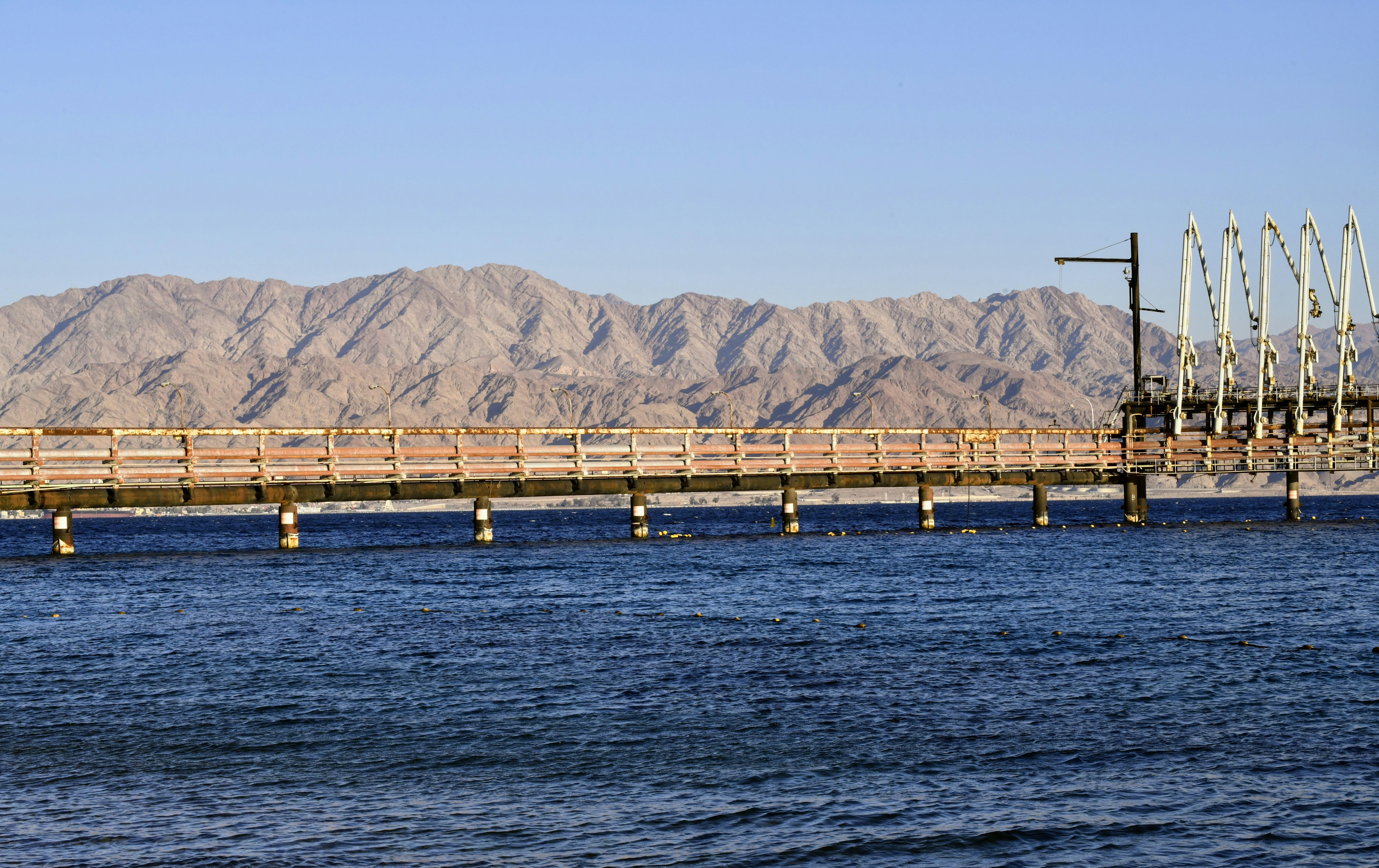 Quiet Span: A Wooden Pier Reaches the Mountain Horizon