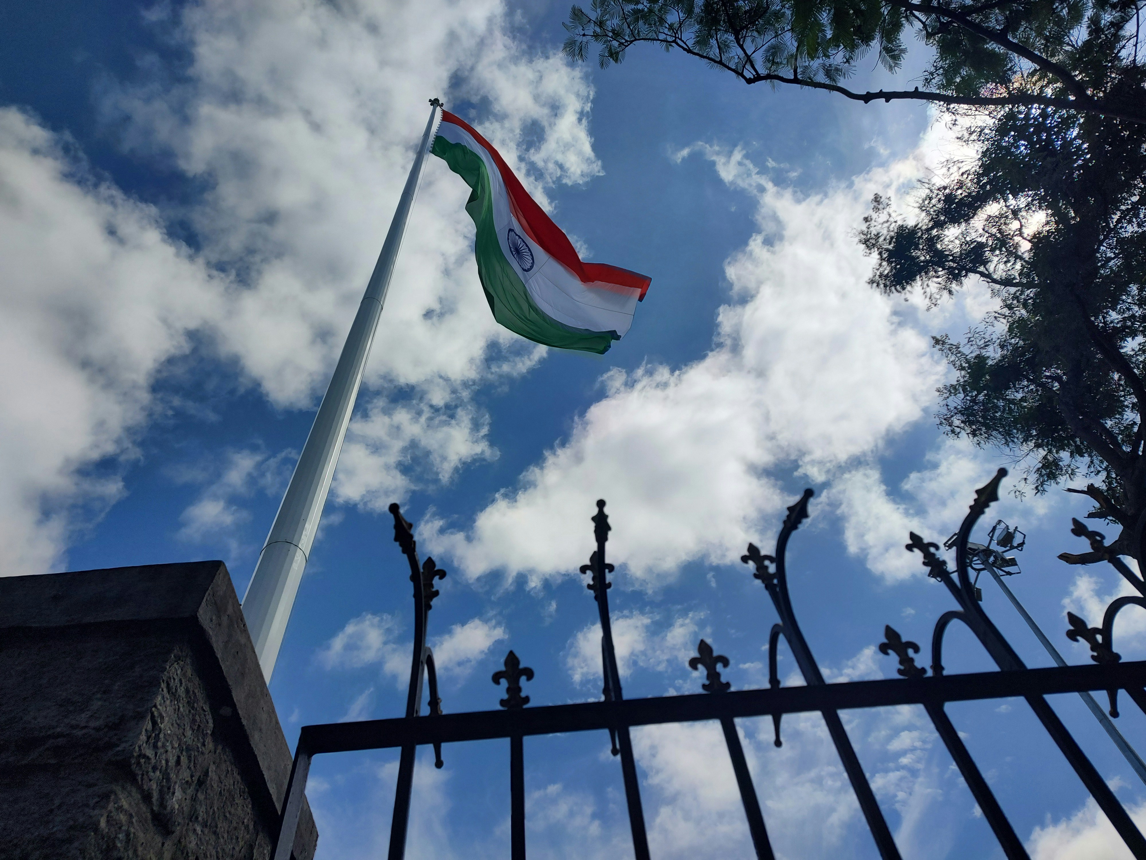 Tri-colour Towering-over | a flag on a pole