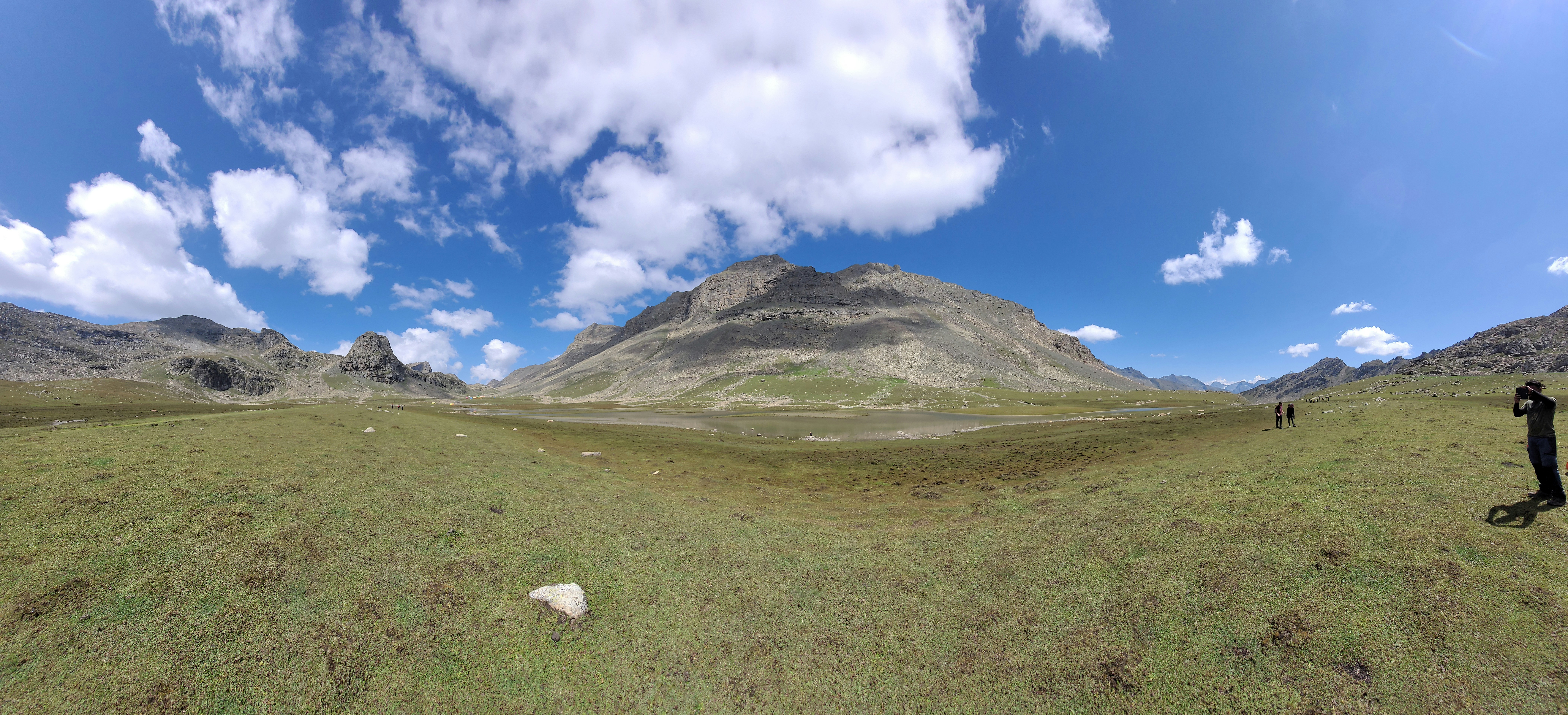 a person standing on a grassy hill