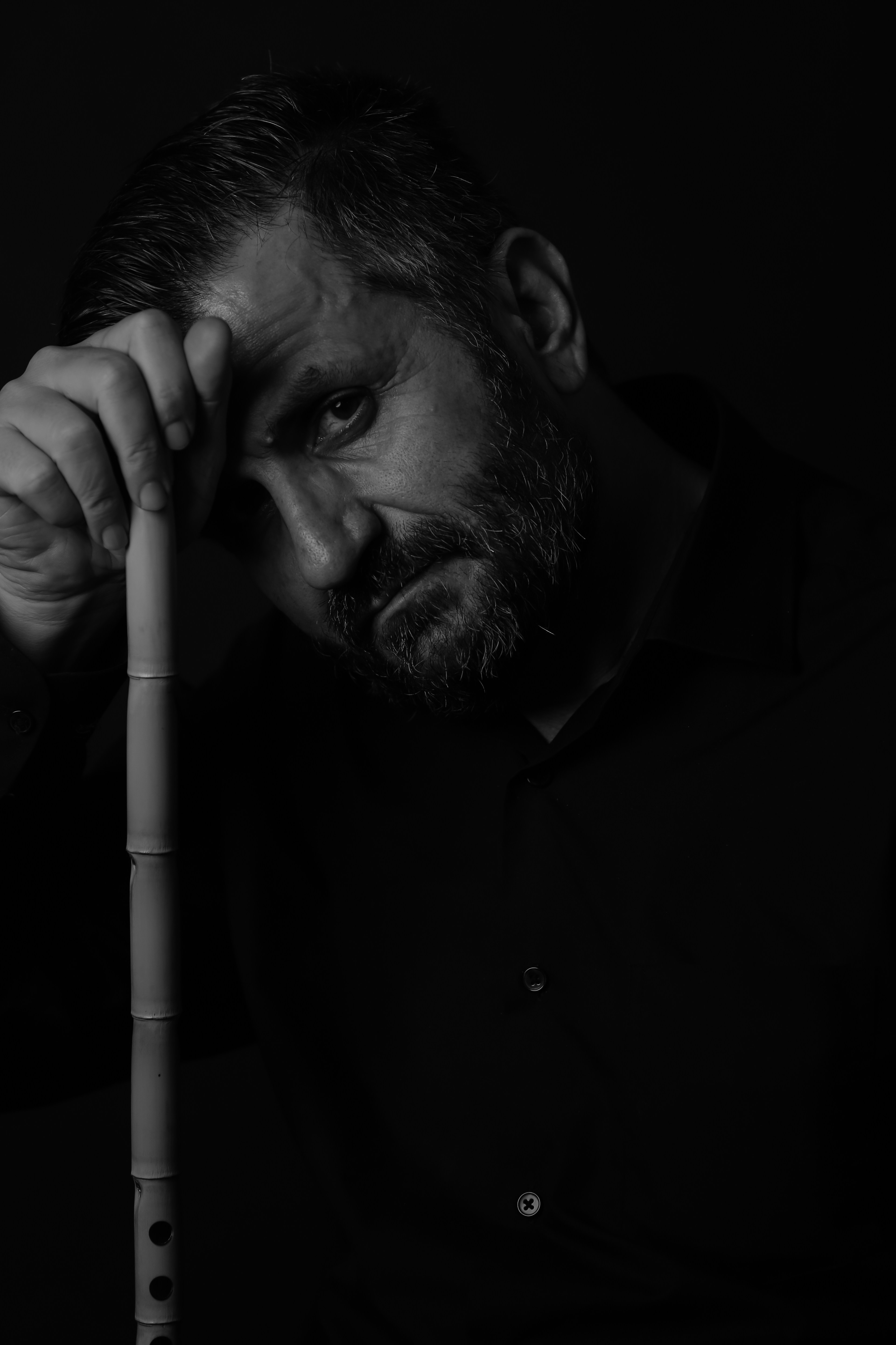 Shadowed Gaze: A Contemplative Portrait in Low Key Light