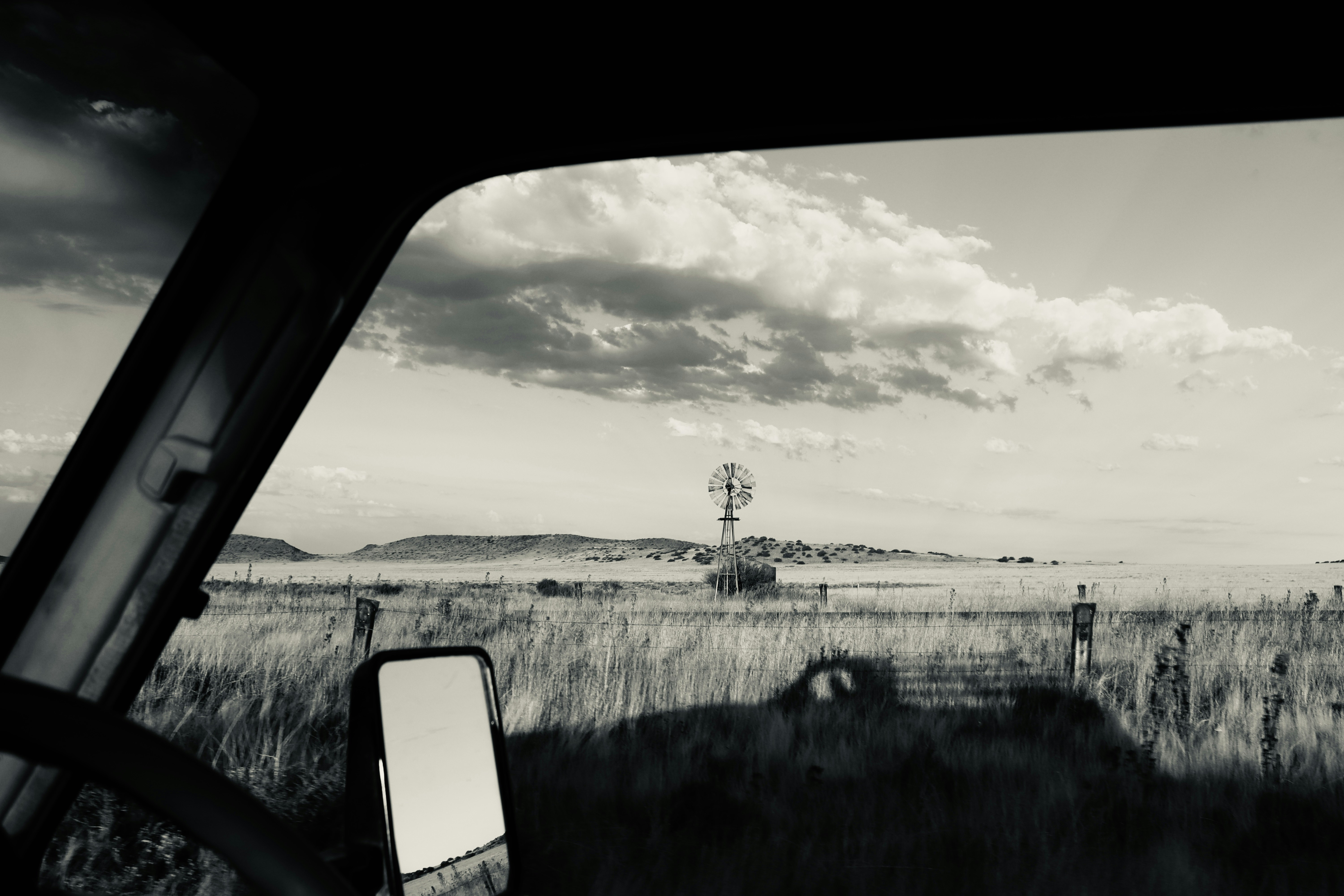 a field with a fence and trees