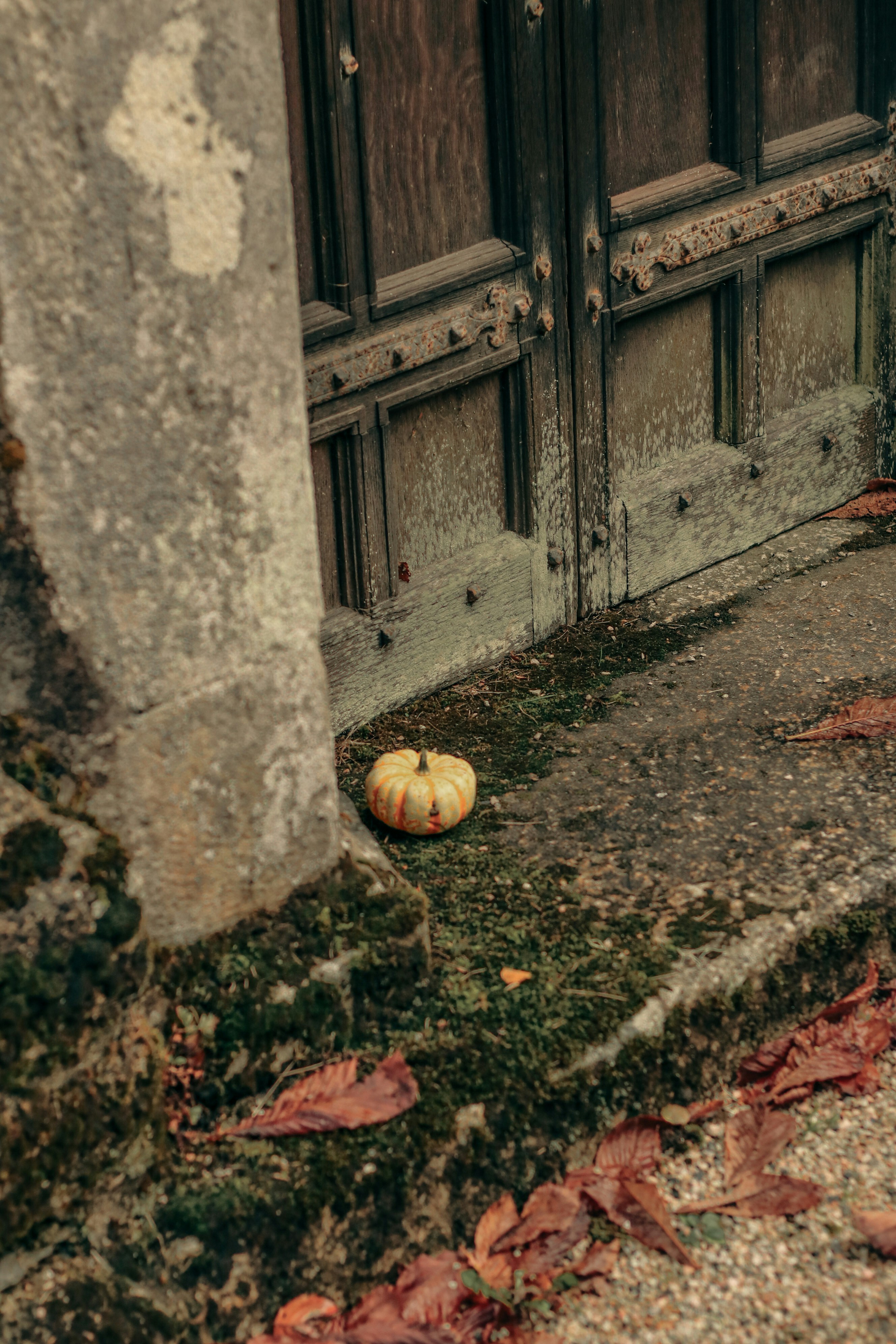 a pumpkin on the ground outside a building