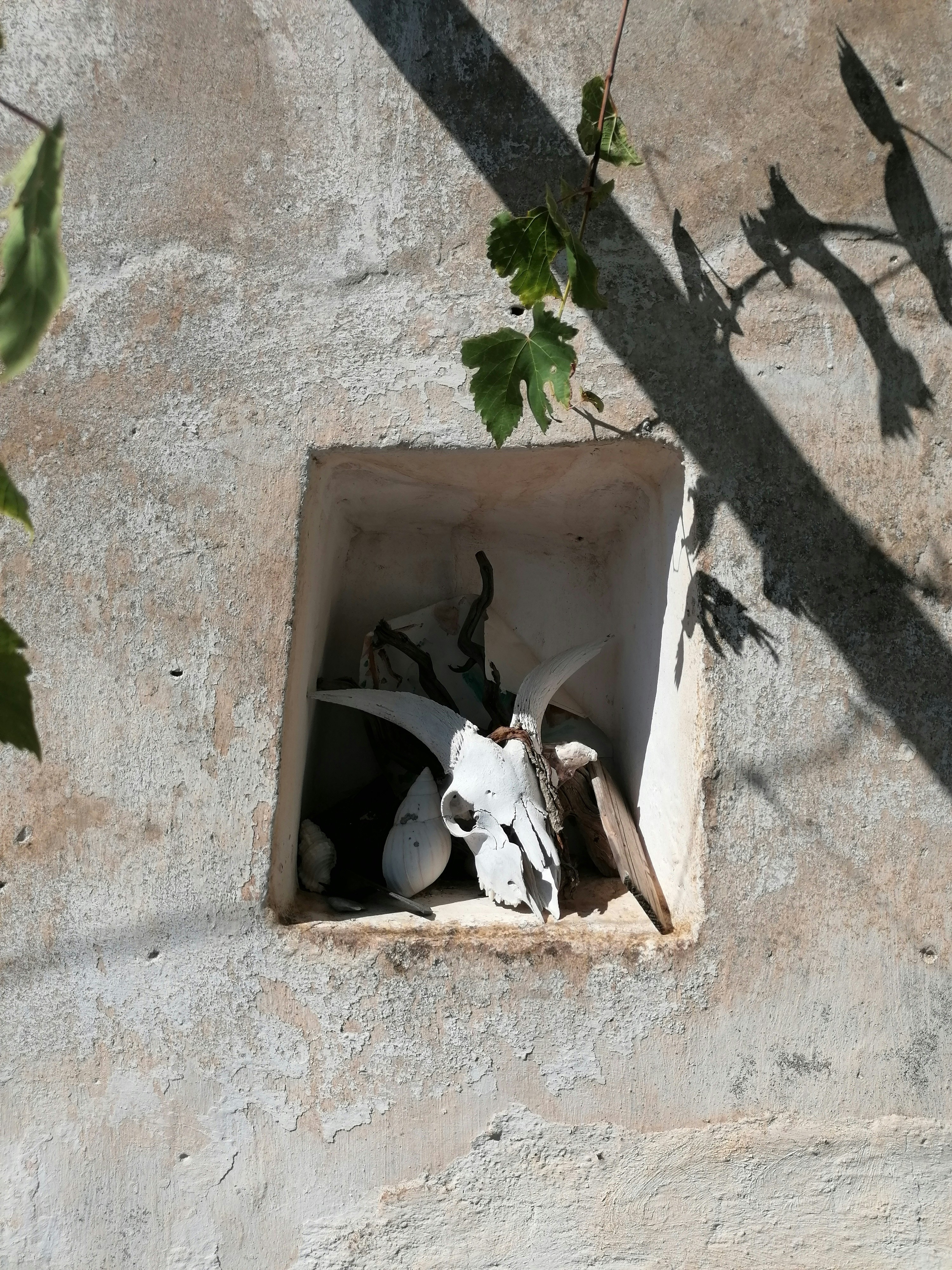 Small shrine in a sunlit wall niche