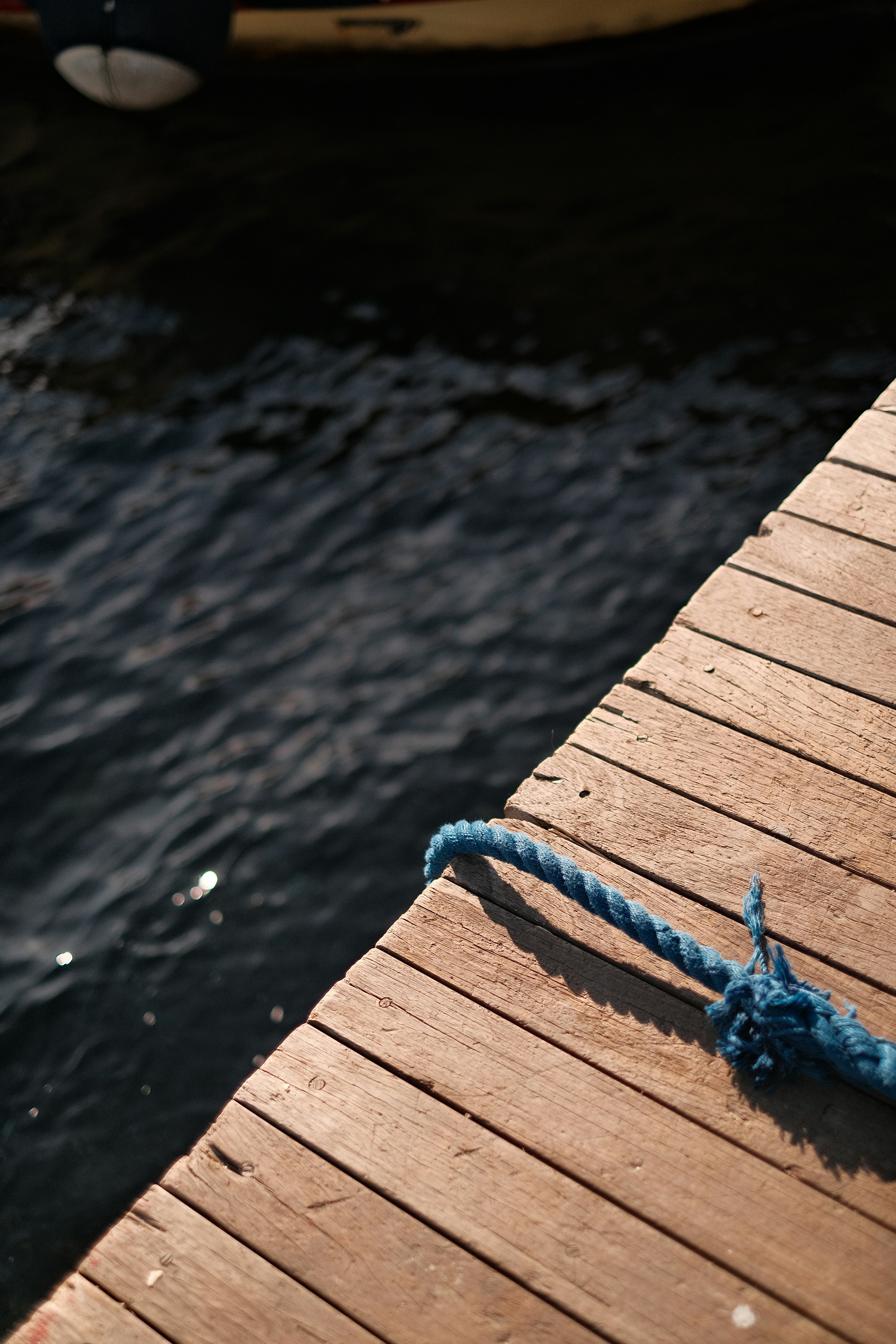 Blue Rope at the Dock's Edge: Weathered Wood and Quiet Water