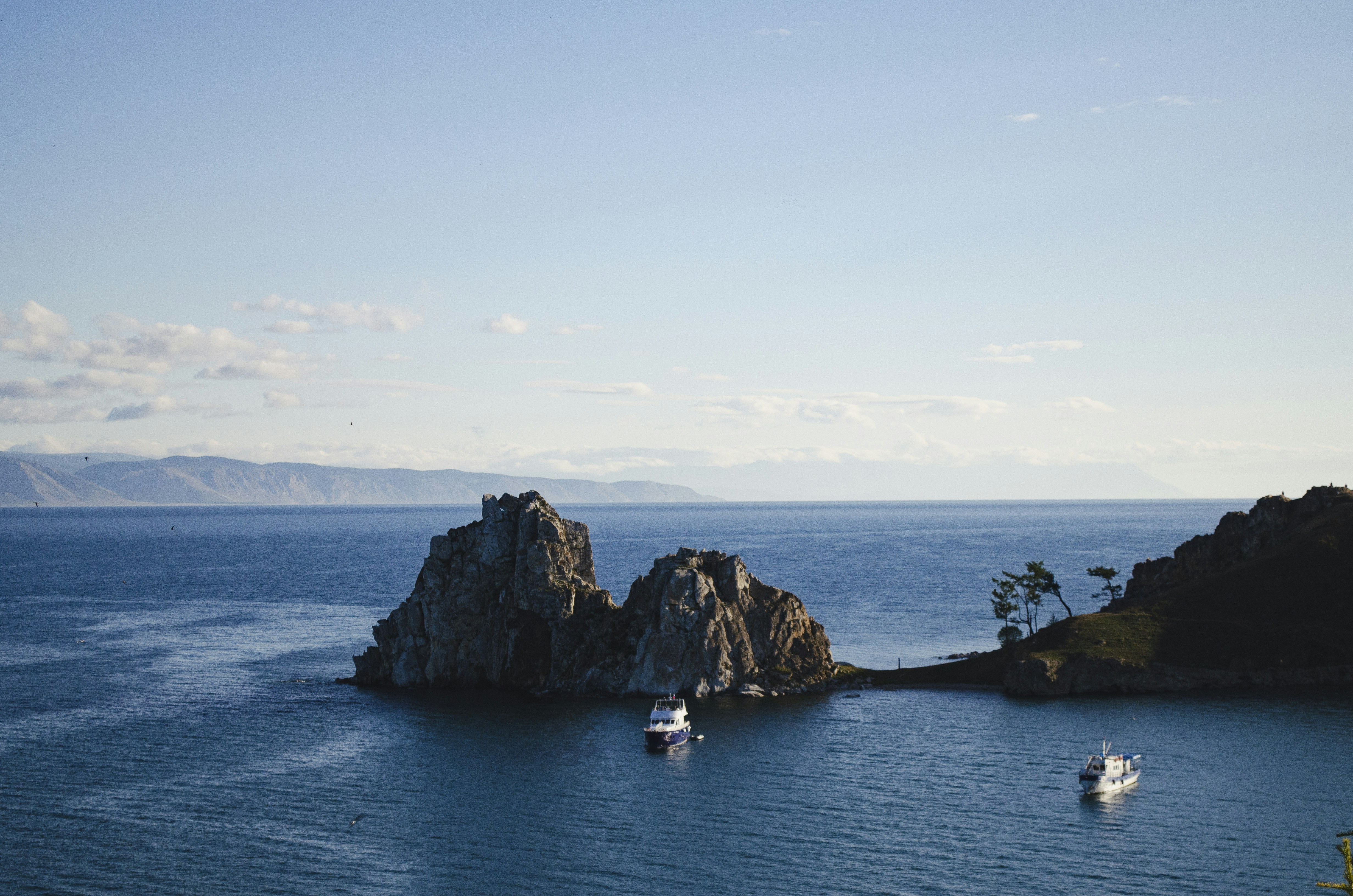 Isolated Serenity: Boats by the Coastal Rocks