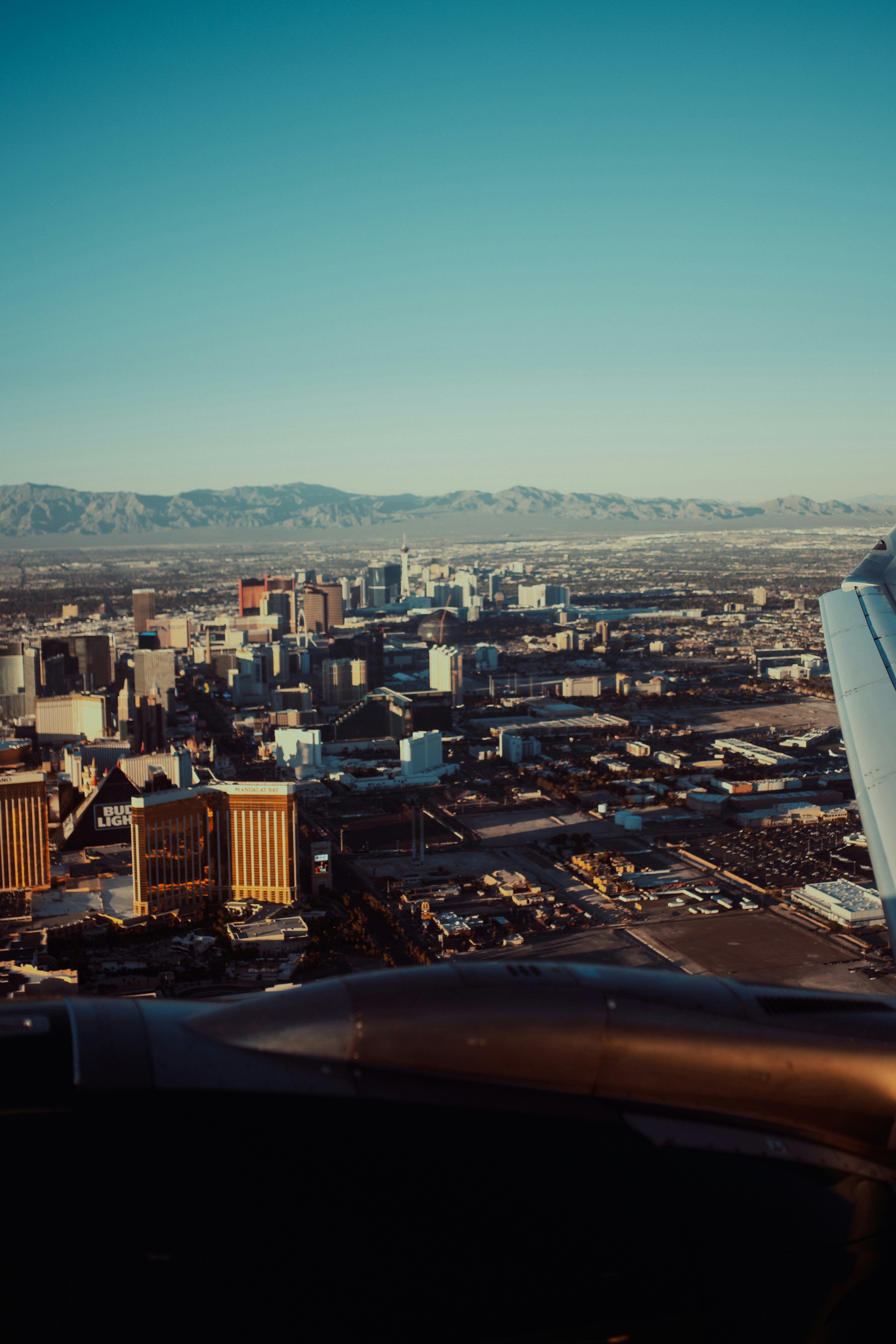 Golden Hour Skyline from a Window Seat Over a Desert Metropolis