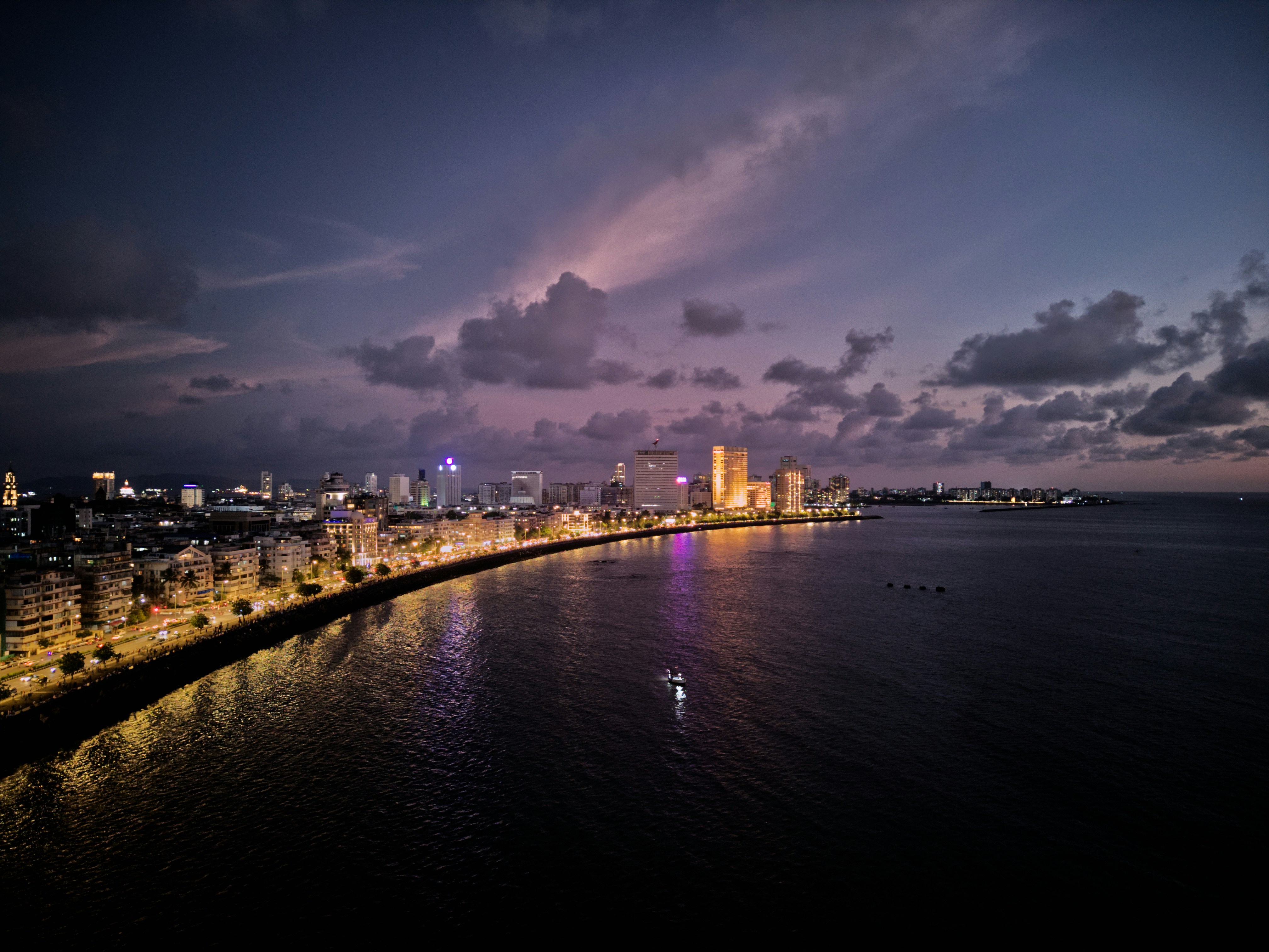Marine drive at dusk | a body of water with a city in the background