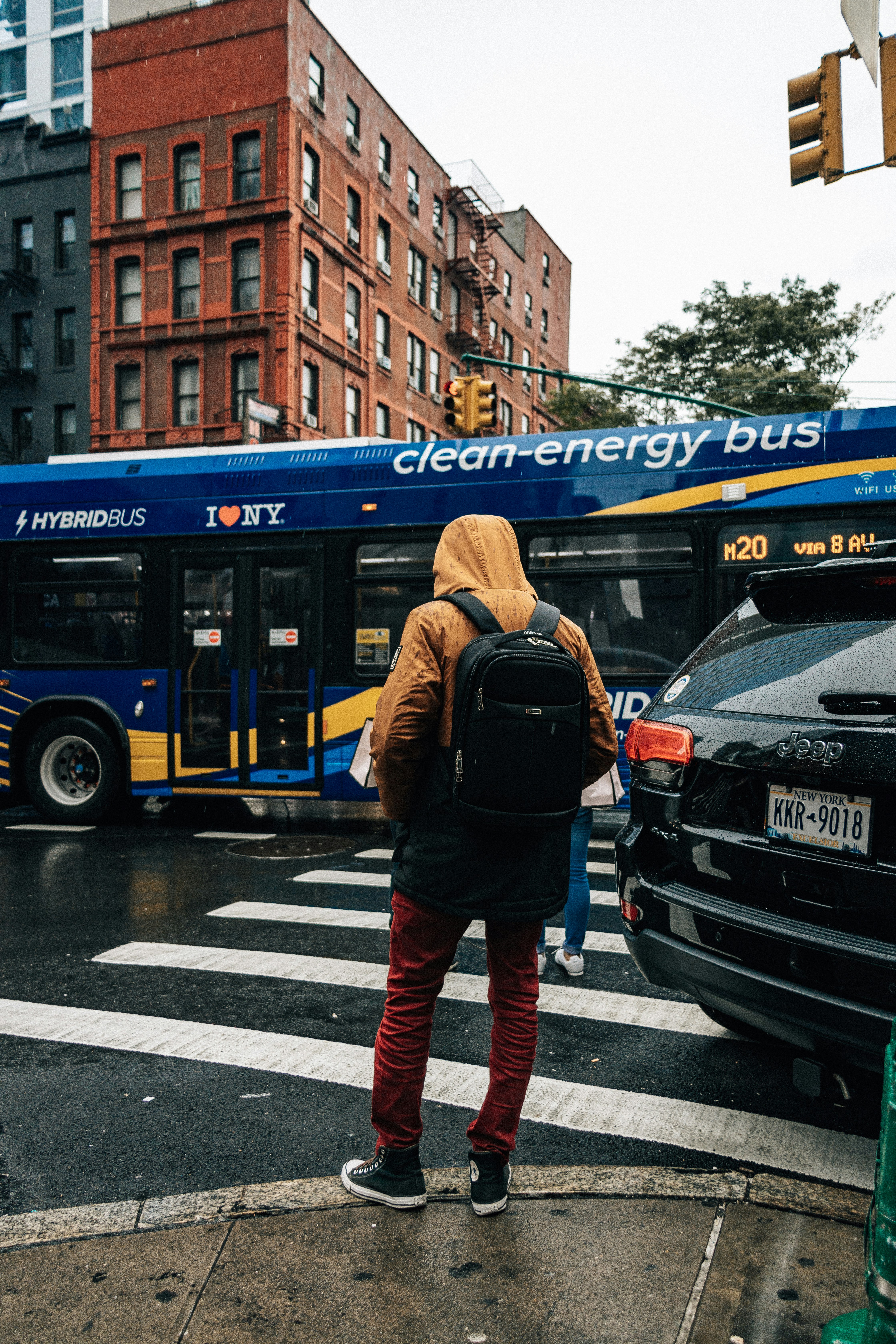 Crosswalk Convergence: Hooded Traveler Meets the Clean-Energy Bus