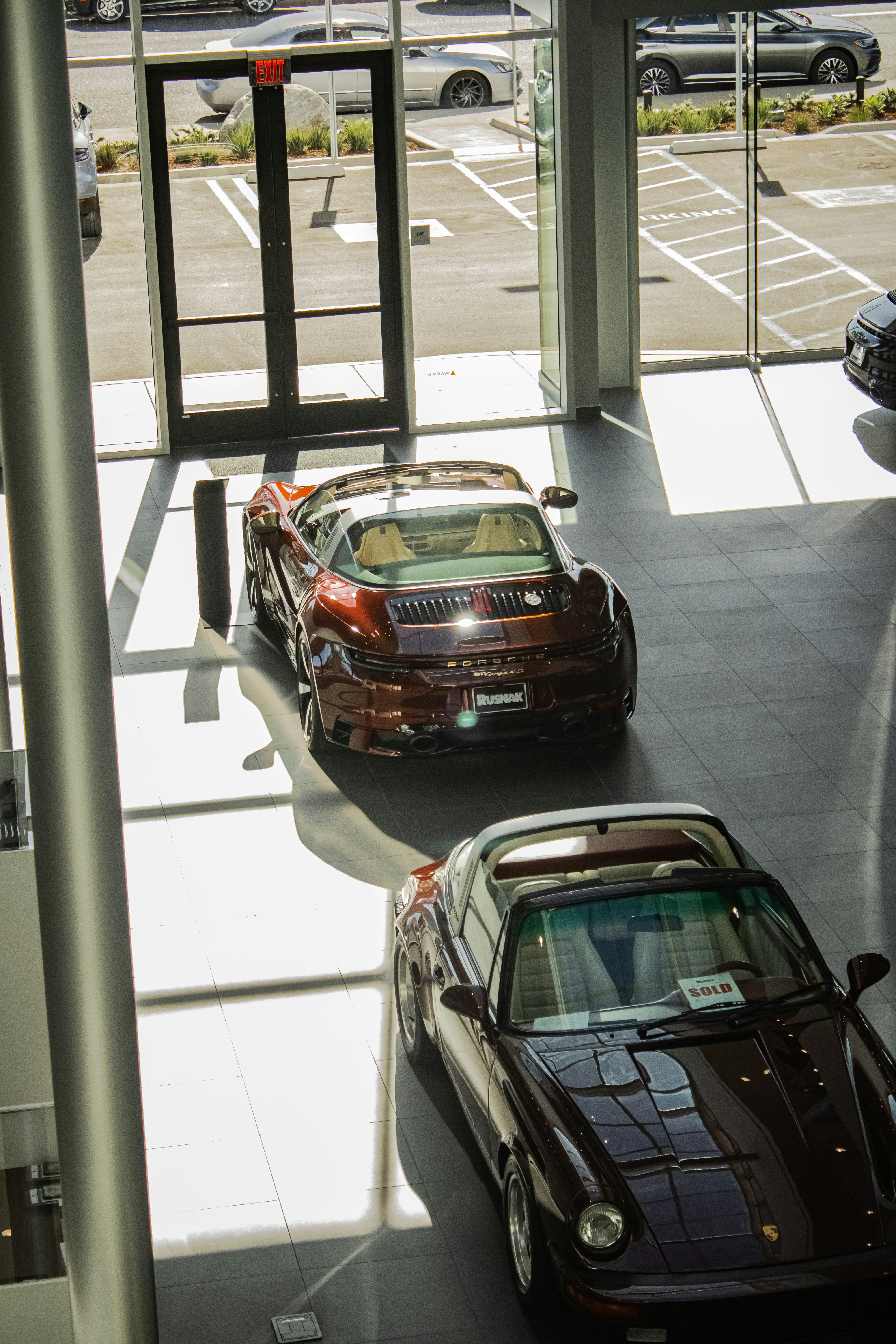 A group of cars parked in a parking lot photo – Free Sports car Image ...