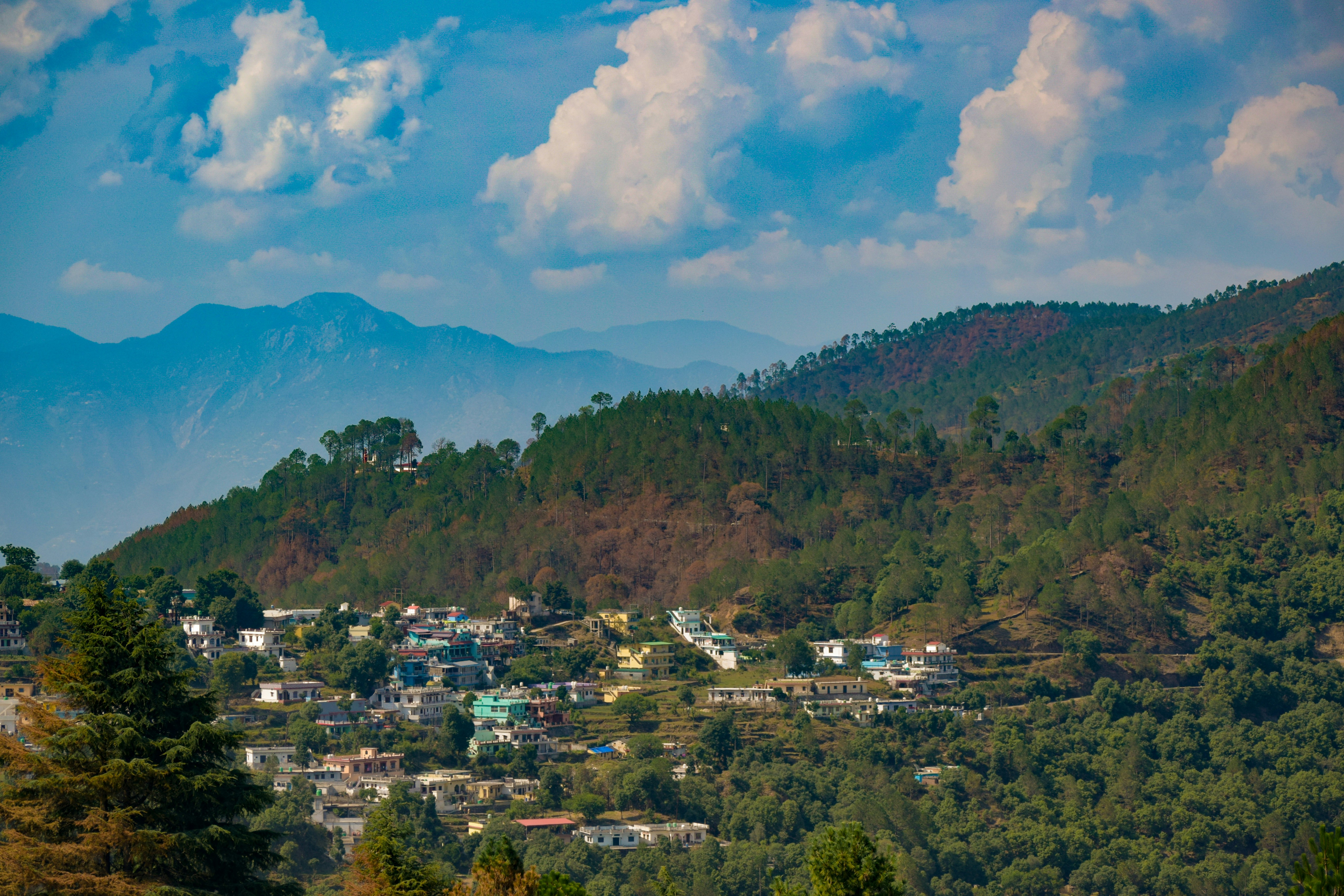A town in the valley between mountains photo – Free Scenery Image on ...