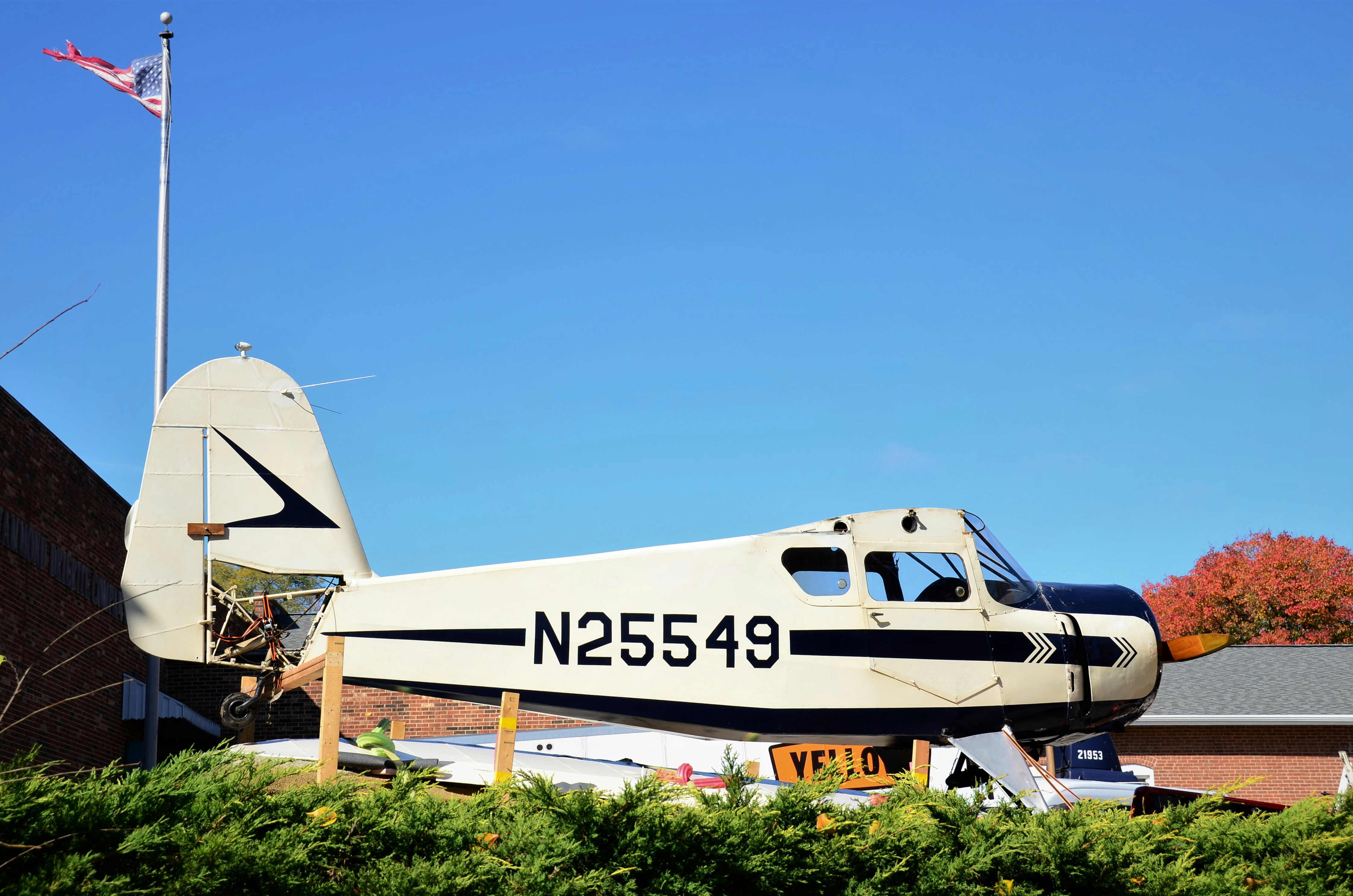 Wings at Rest: Vintage Plane Exhibited Against a Clear Blue Sky
