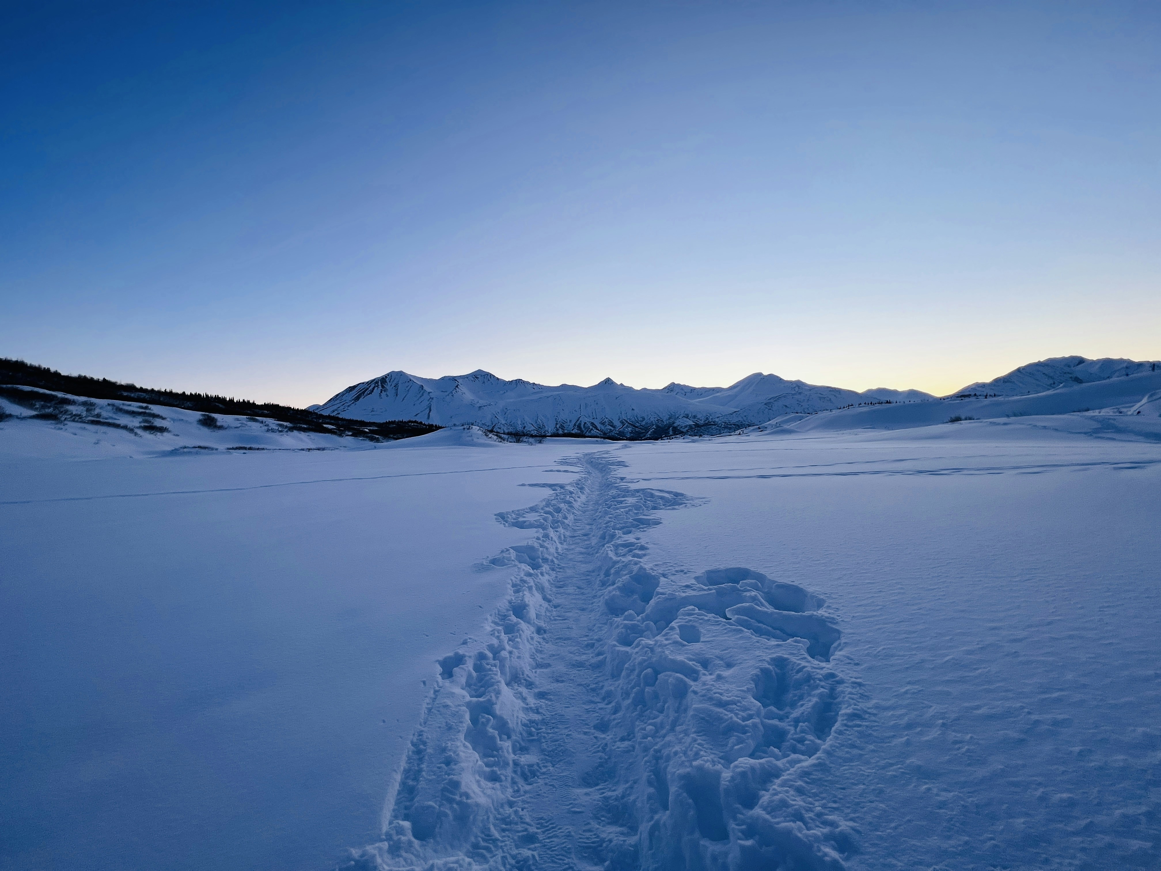 A snowy landscape with mountains in the background photo – Free Winter ...