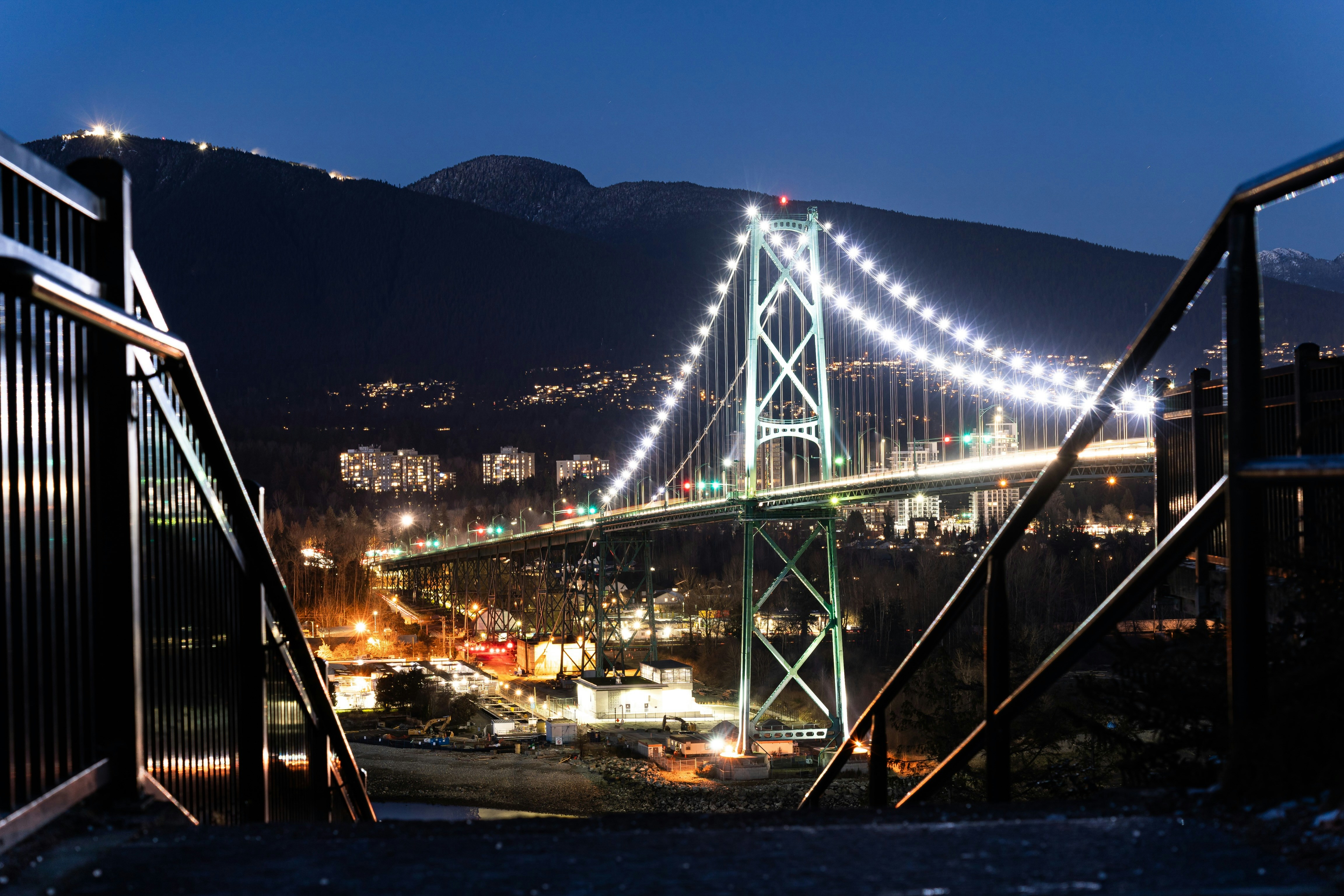Luminous Span: Night Bridge Framed by Rails