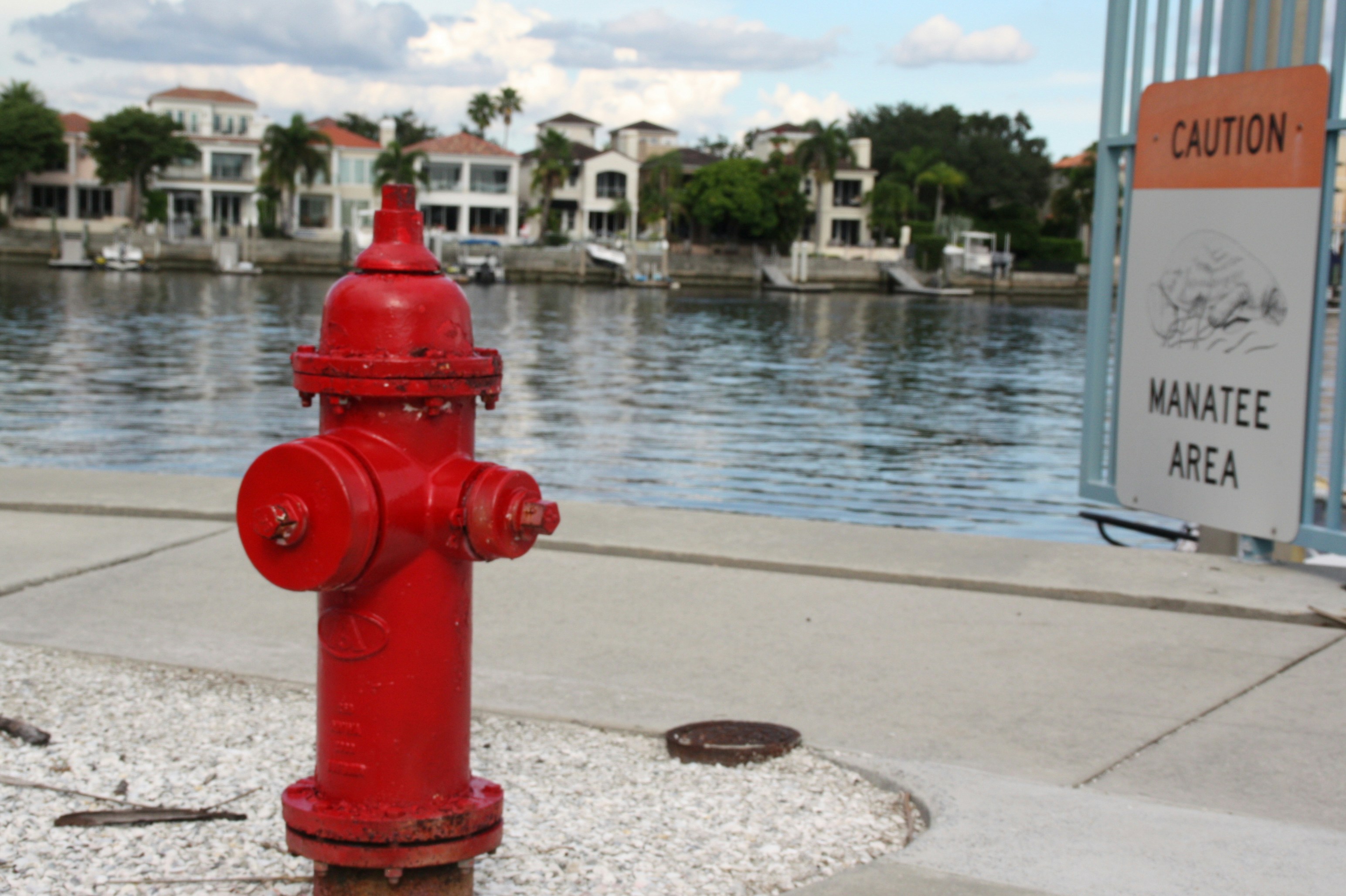 a red fire hydrant next to a sign