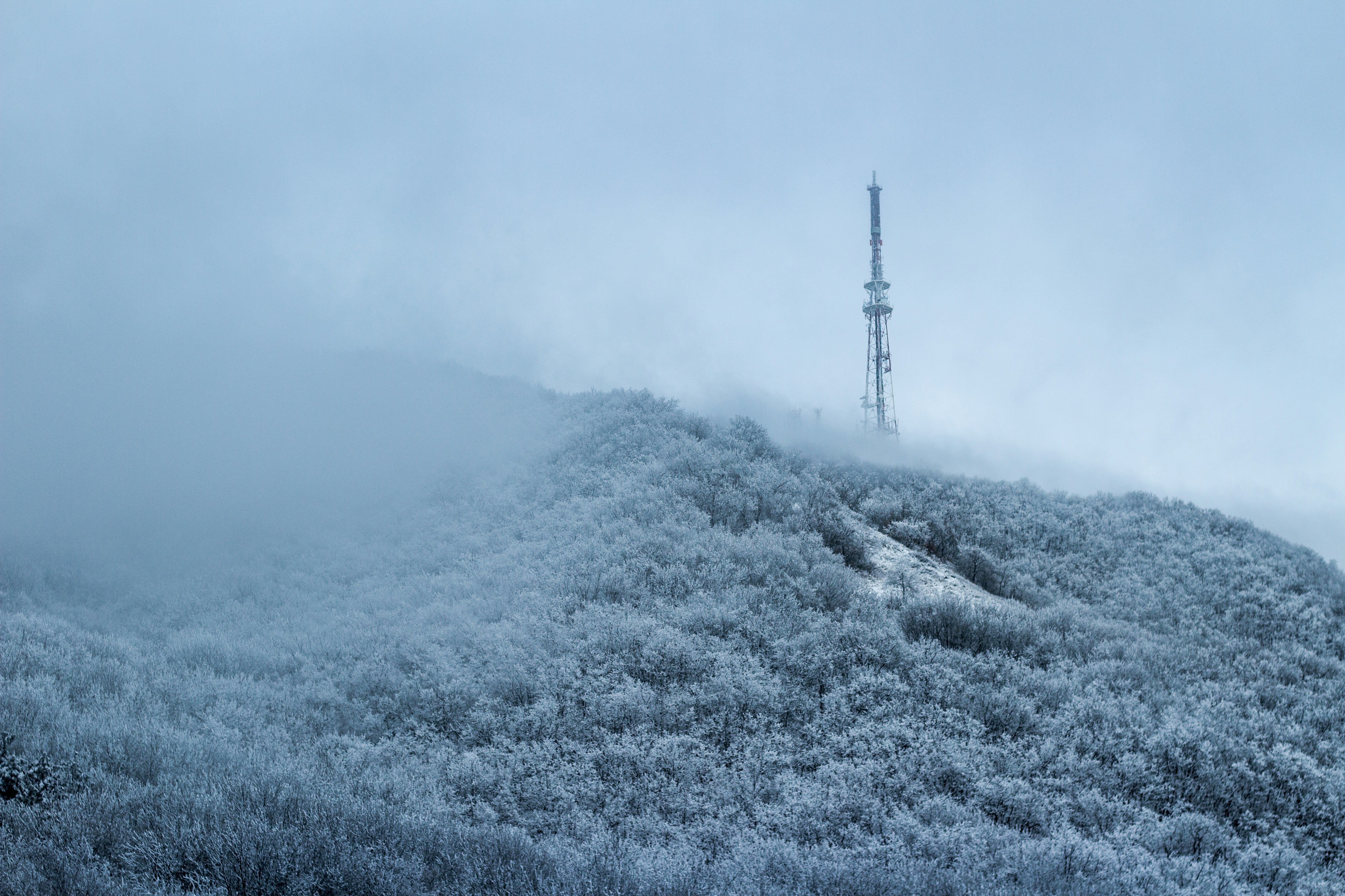Mist-enshrouded Summit: The Frost-locked Tower on a Hilltop Ridge