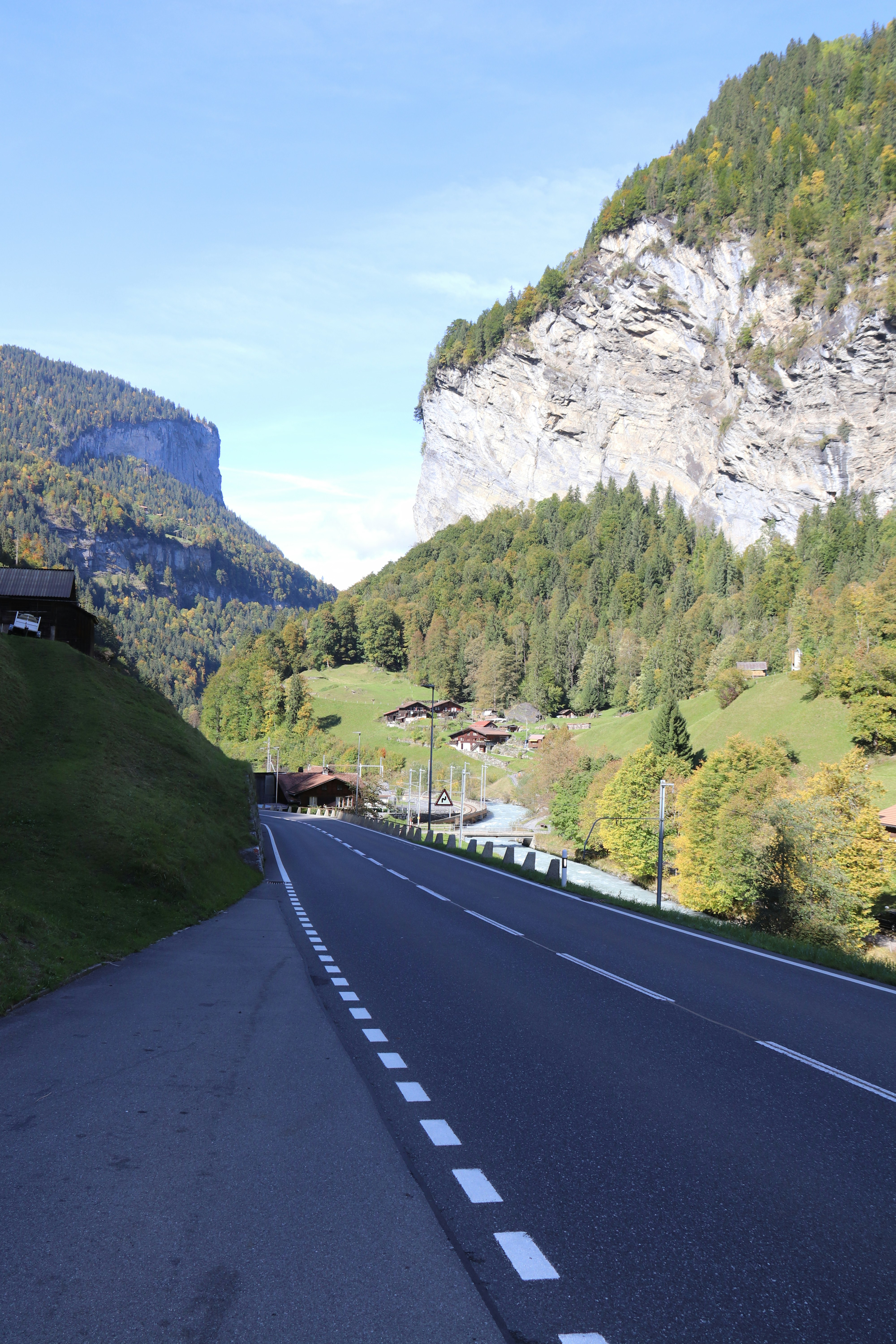 Road Through a Mountain Village Under a Bright Sky