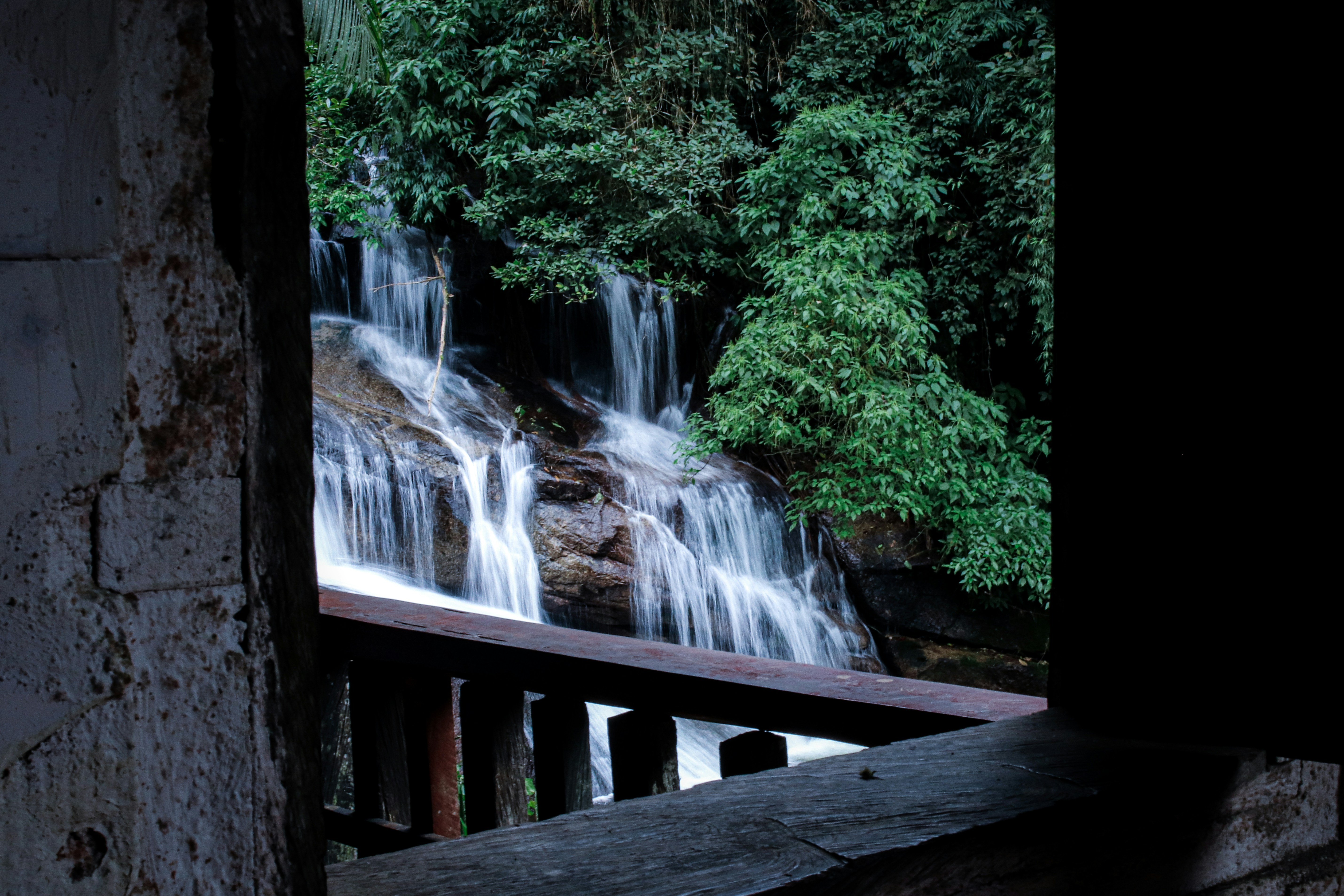 Hidden Cascade Framed by Stone and Shadow