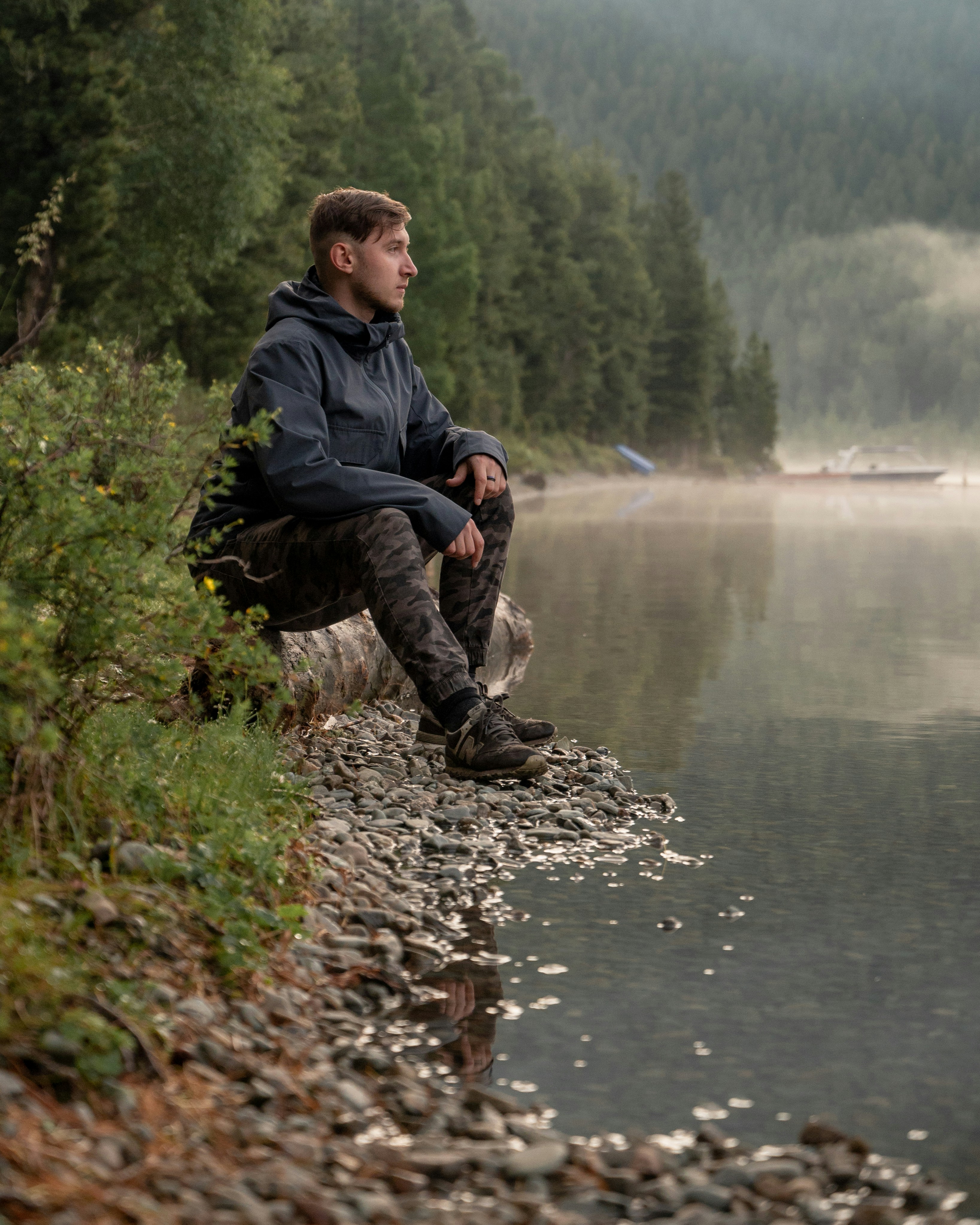 Edge of Quiet: A solitary figure on a mist-kissed lakeside