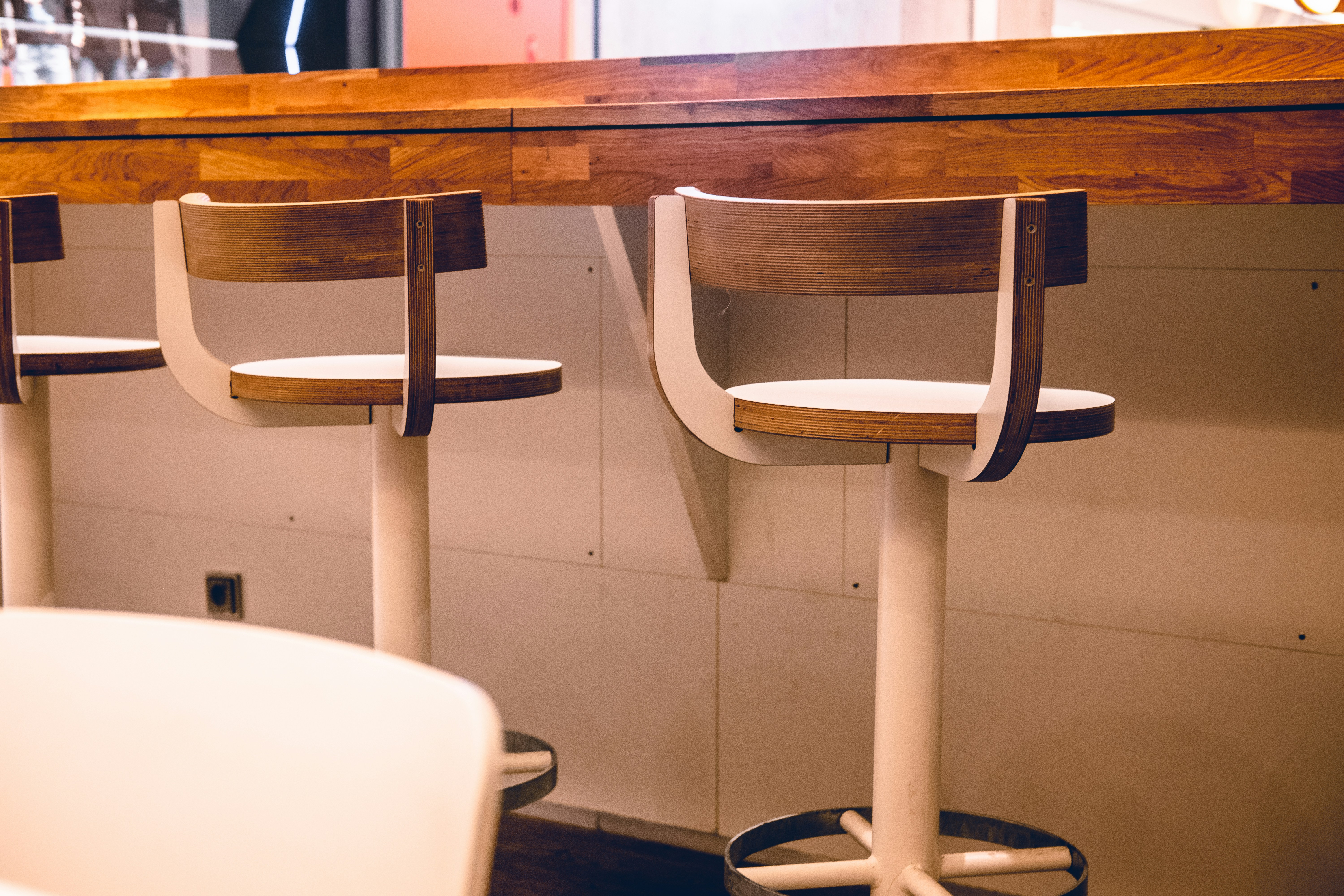 Warm Geometry at the Counter: Two Bar Stools Under Soft Ambient Light