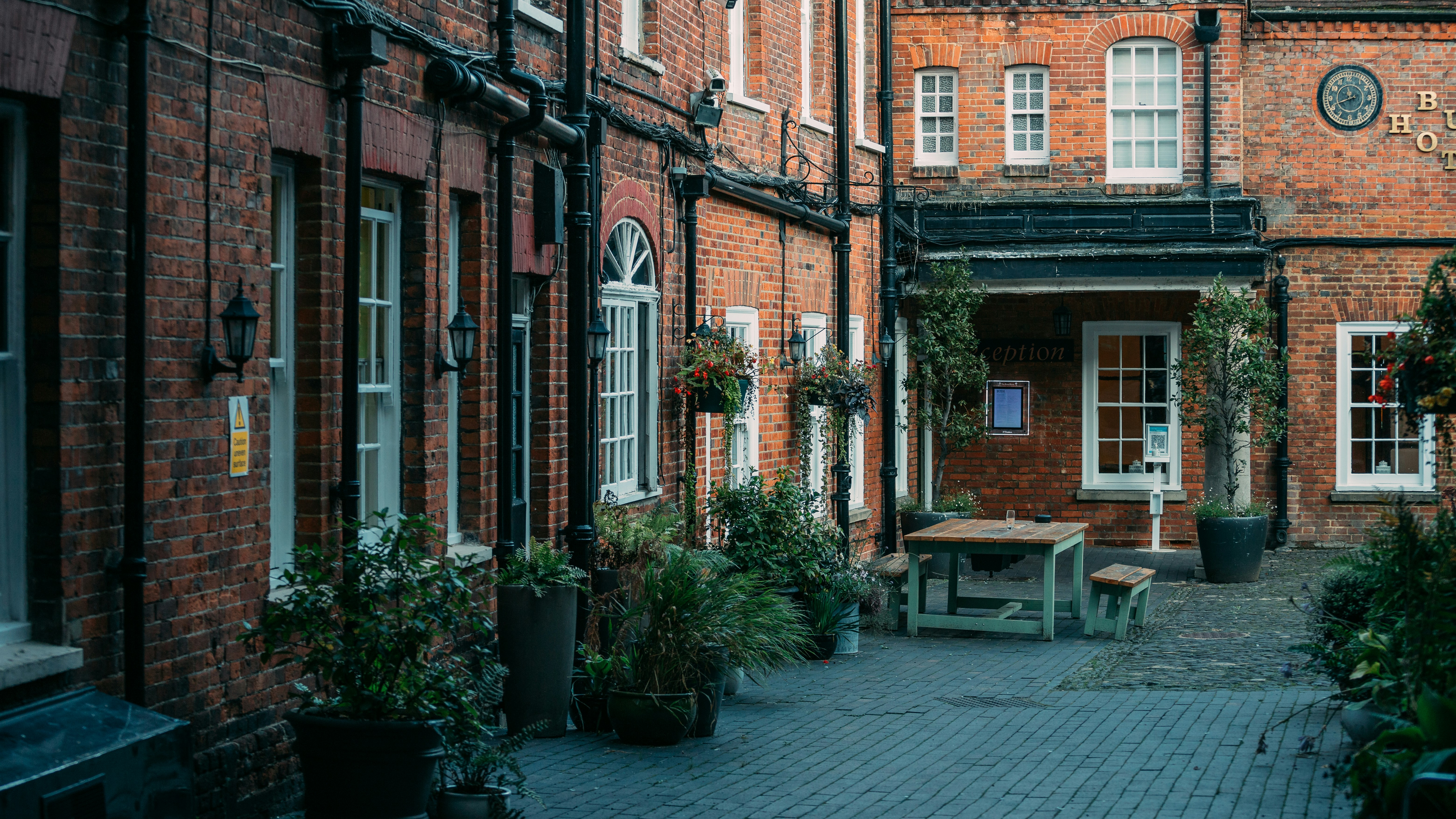 A brick building with a brick patio photo – Free Farnham Image on Unsplash