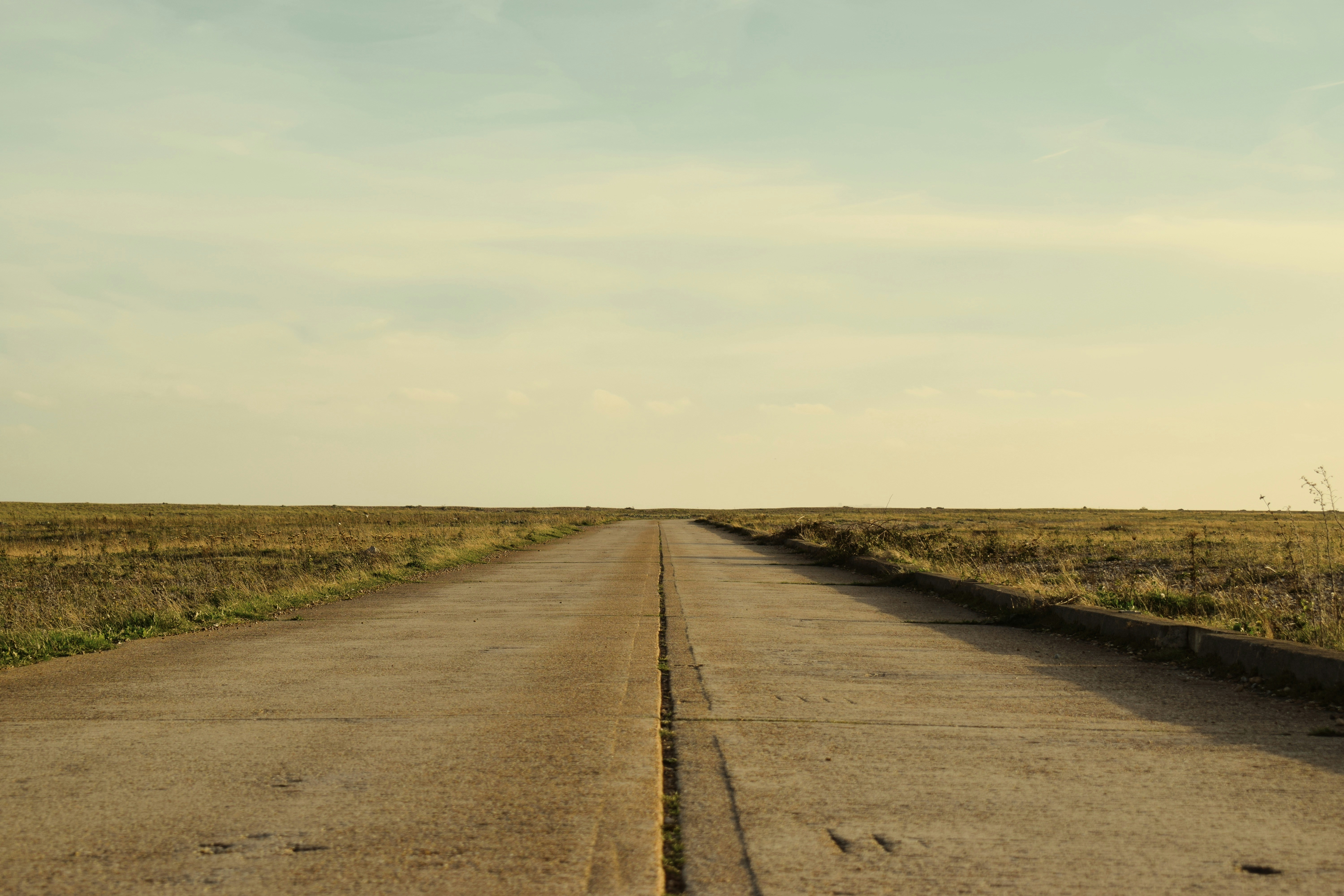 Vanishing Line: A Desolate Highway Stretch Toward the Distant Horizon