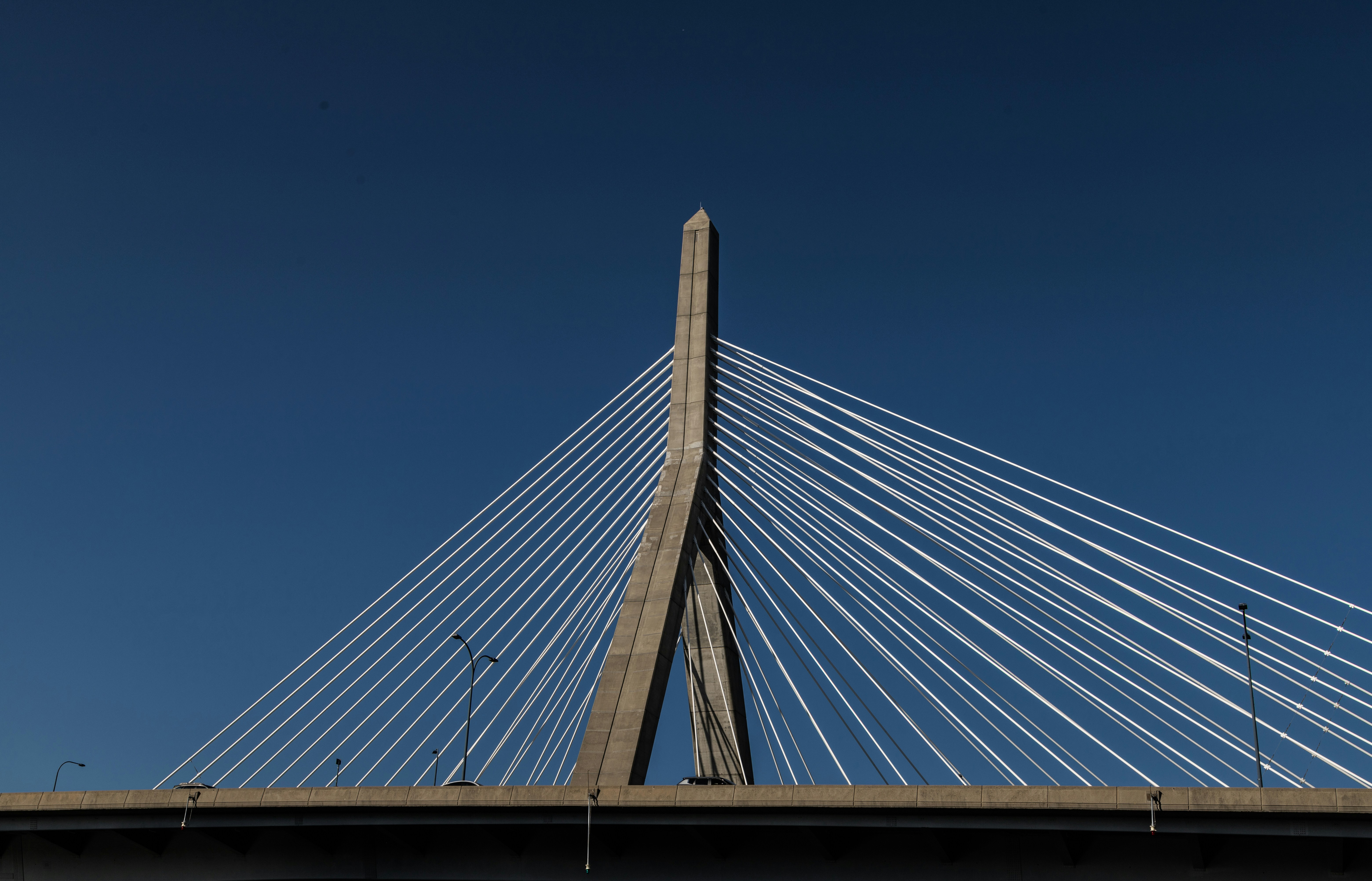 A large bridge with cables with Leonard P. Zakim Bunker Hill Memorial ...