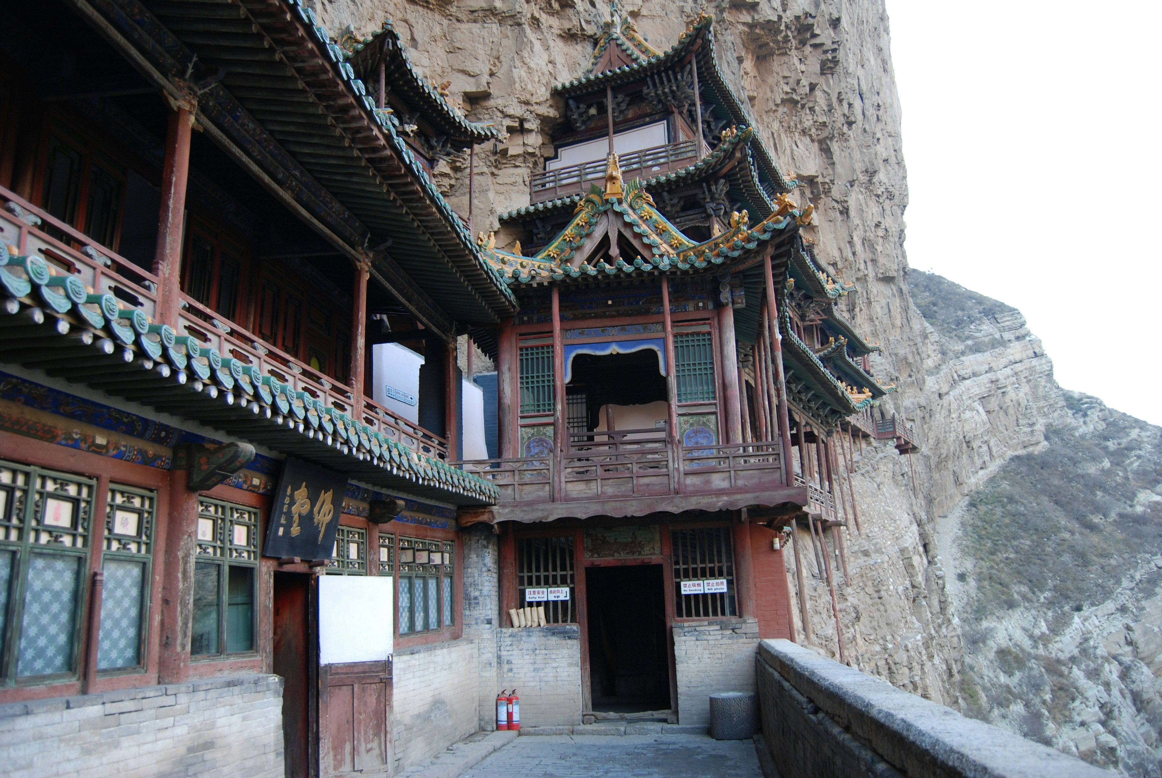 Cliffside Temple Facade: Balancing Wooden Detail and Stone Canyon