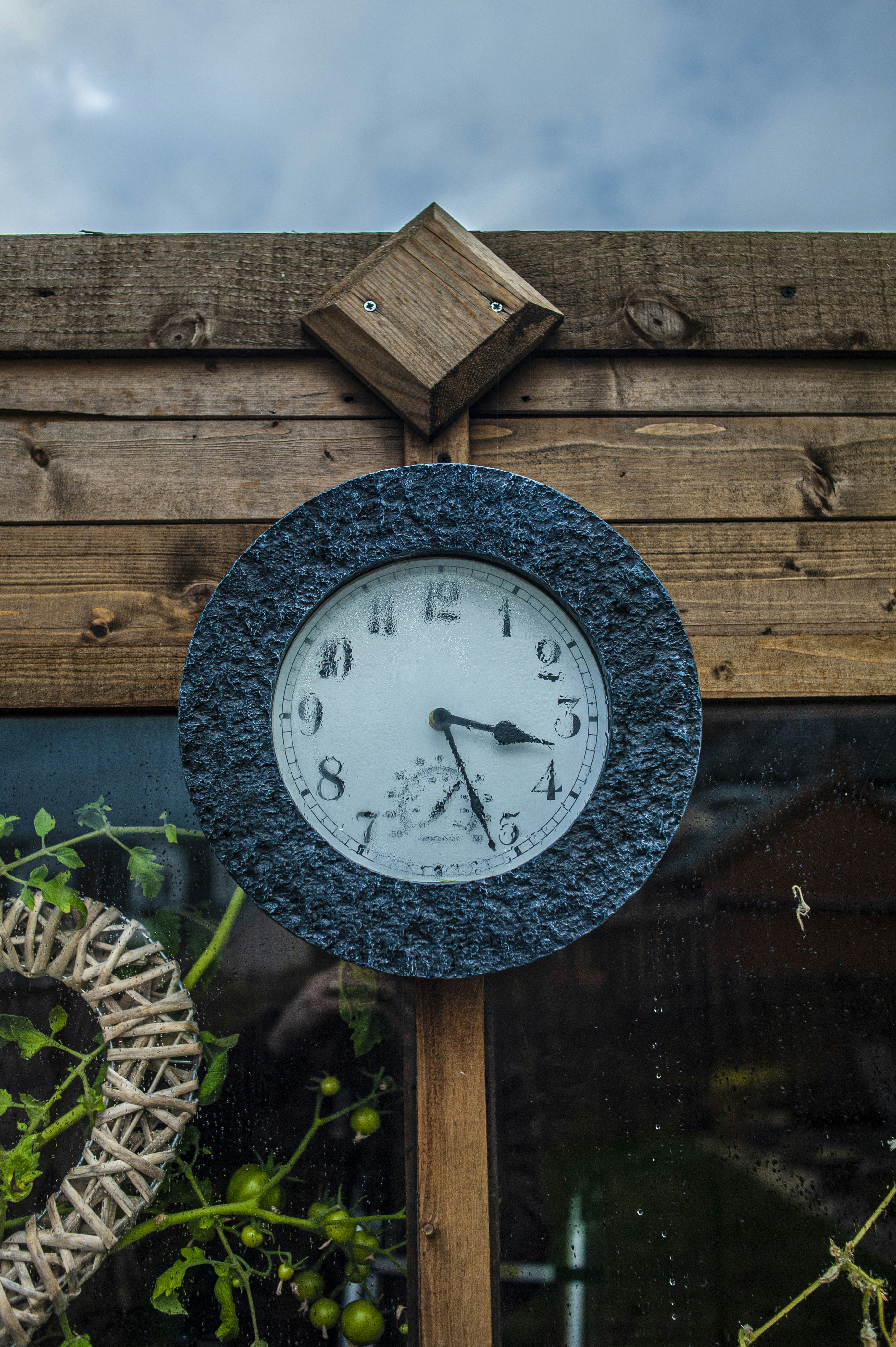 Clock in a Rustic Frame: Time Paused on Weathered Wood
