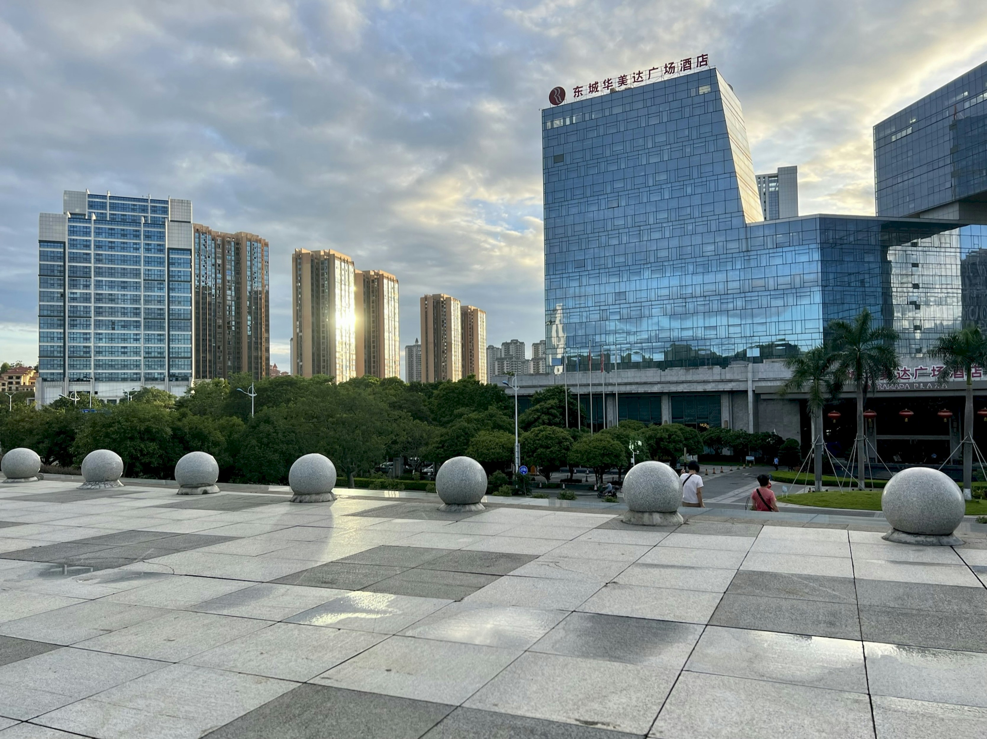 Orb-Guarded Plaza Under a Sea of Blue Glass Skyscrapers